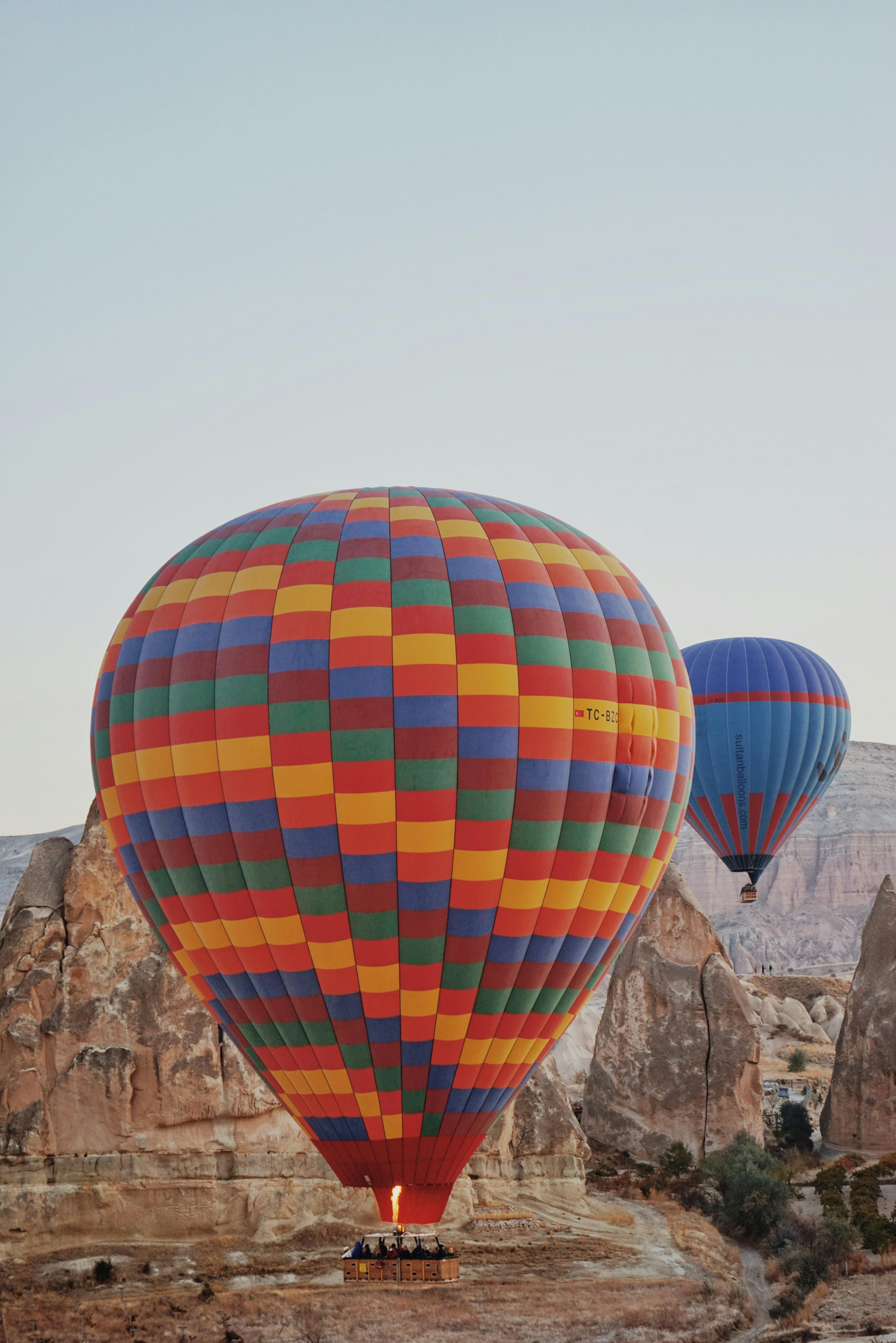Hot Air Balloons Flying among Rock Formations · Free Stock Photo