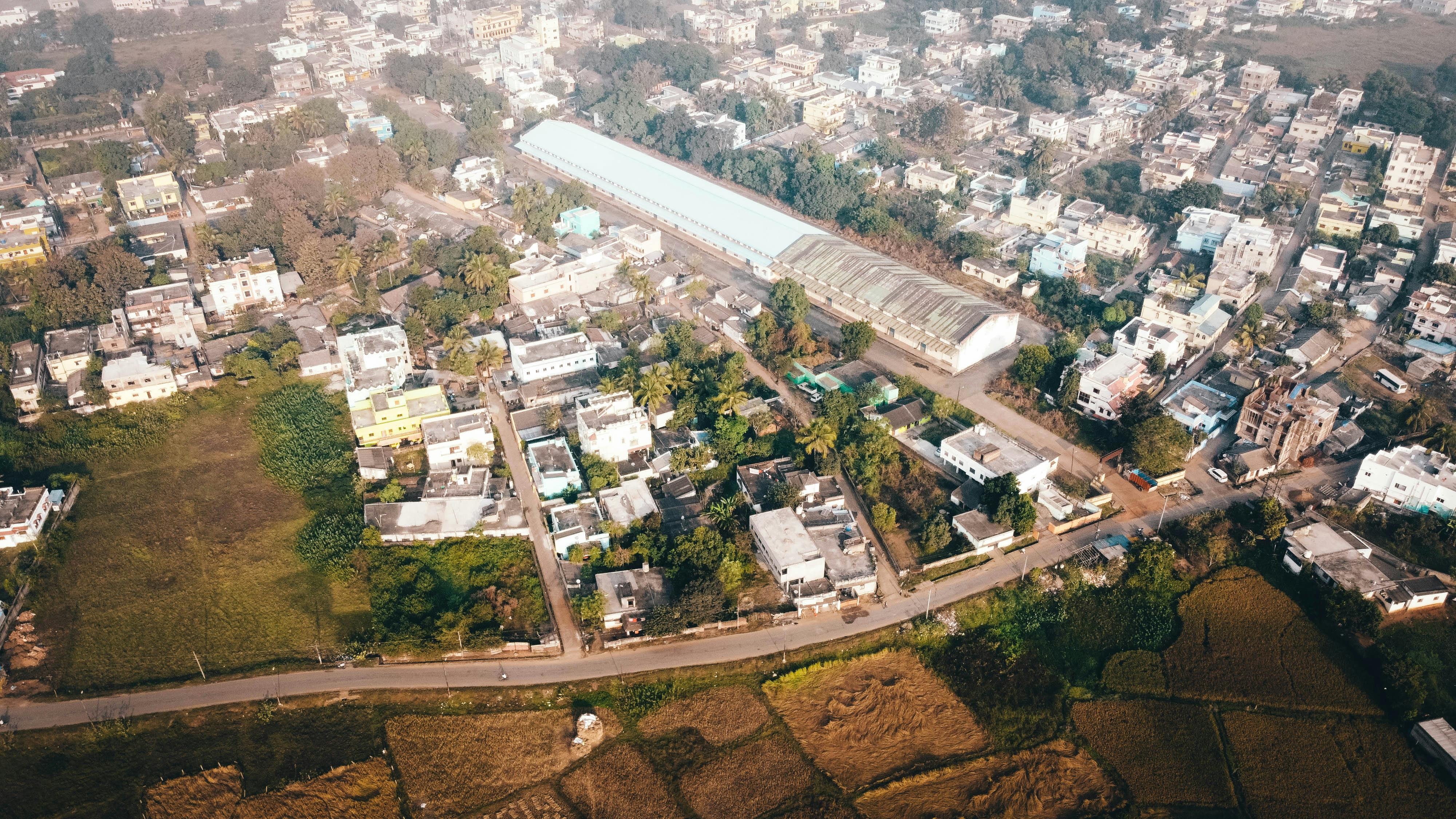 Aerial View of a Town Surrounded by Fields · Free Stock Photo