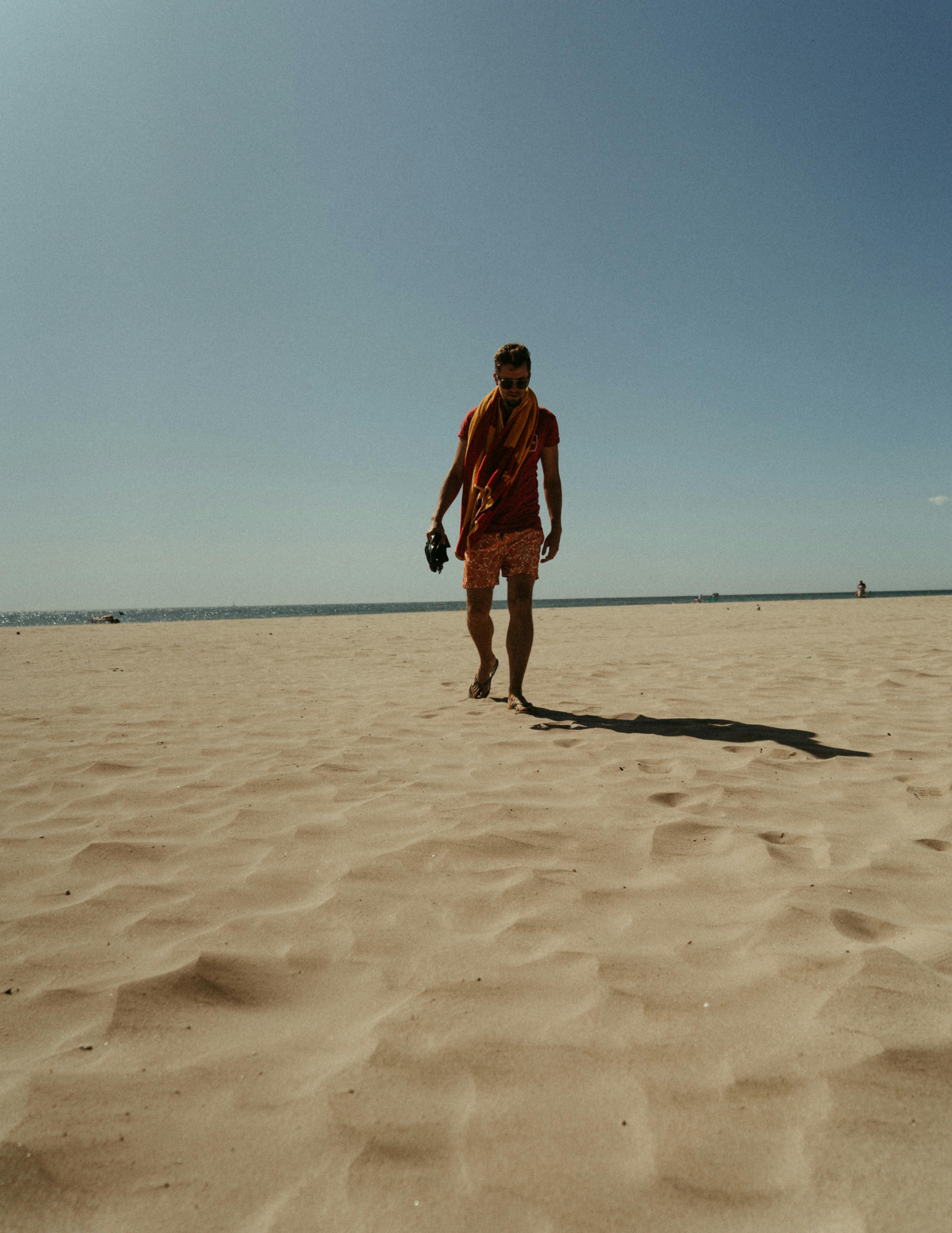 Man Walking on Sand · Free Stock Photo