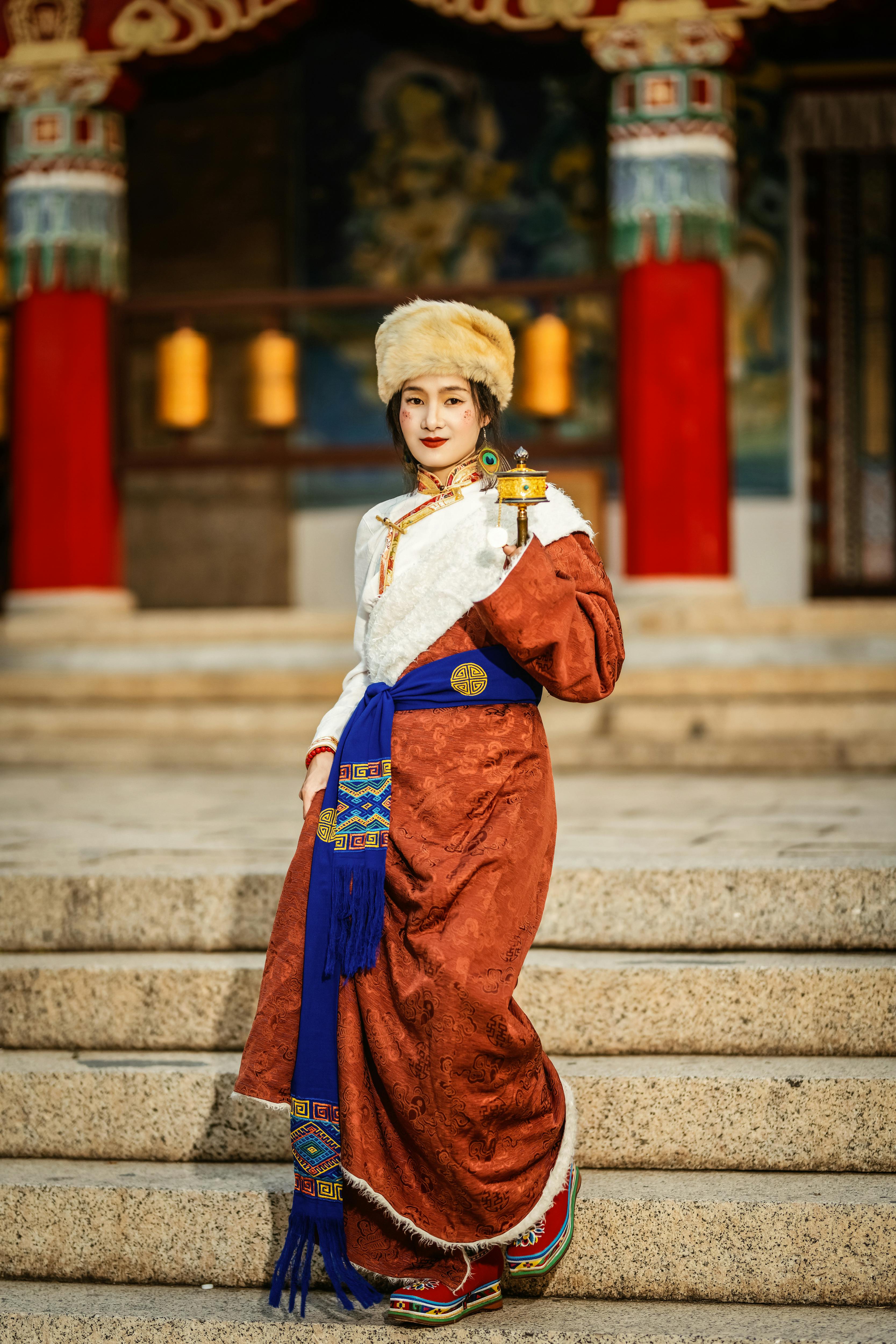 Woman in Traditional Clothing Posing on Temple Stairs · Free Stock Photo