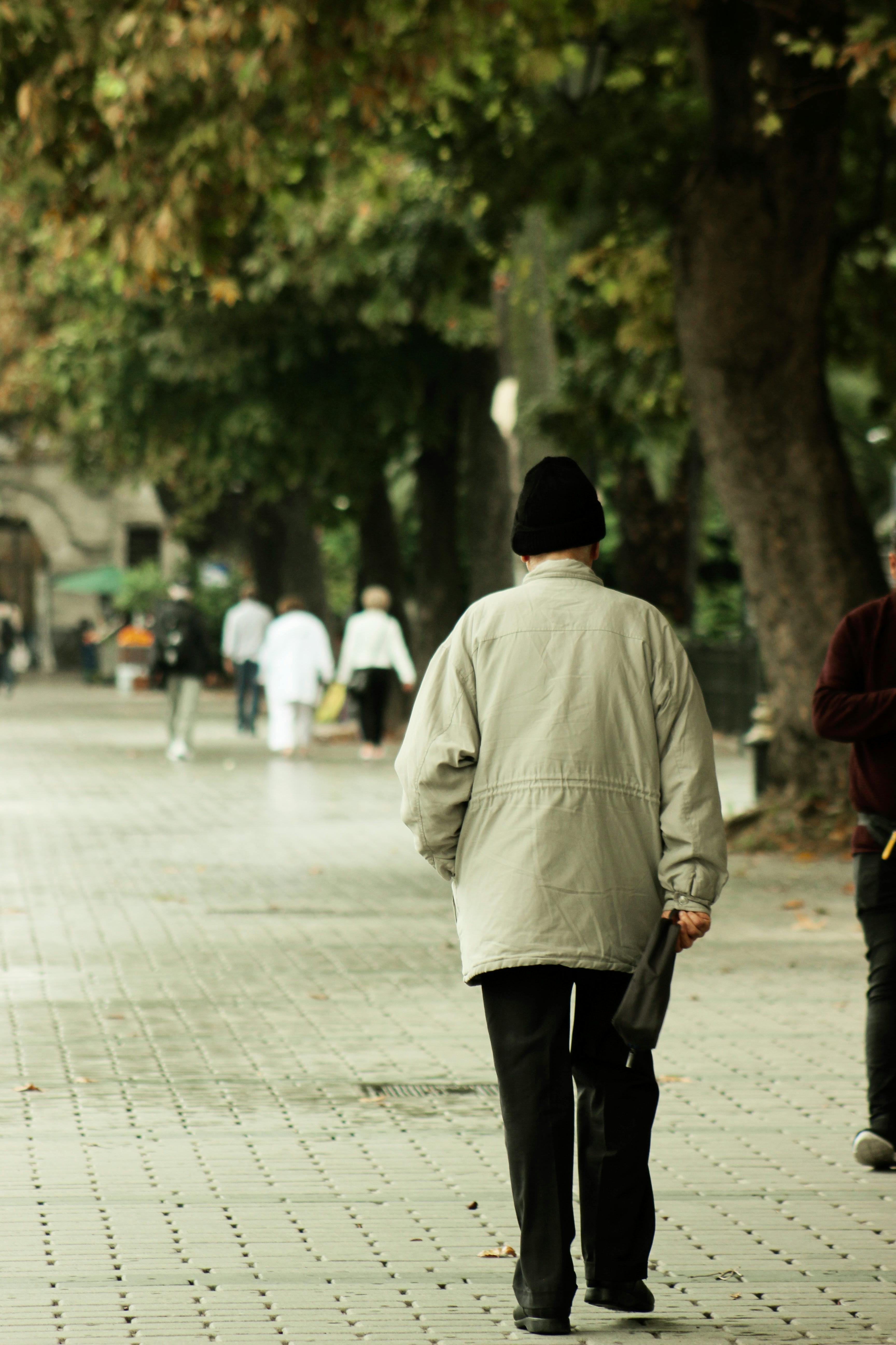 Man Walking along Sidewalk · Free Stock Photo