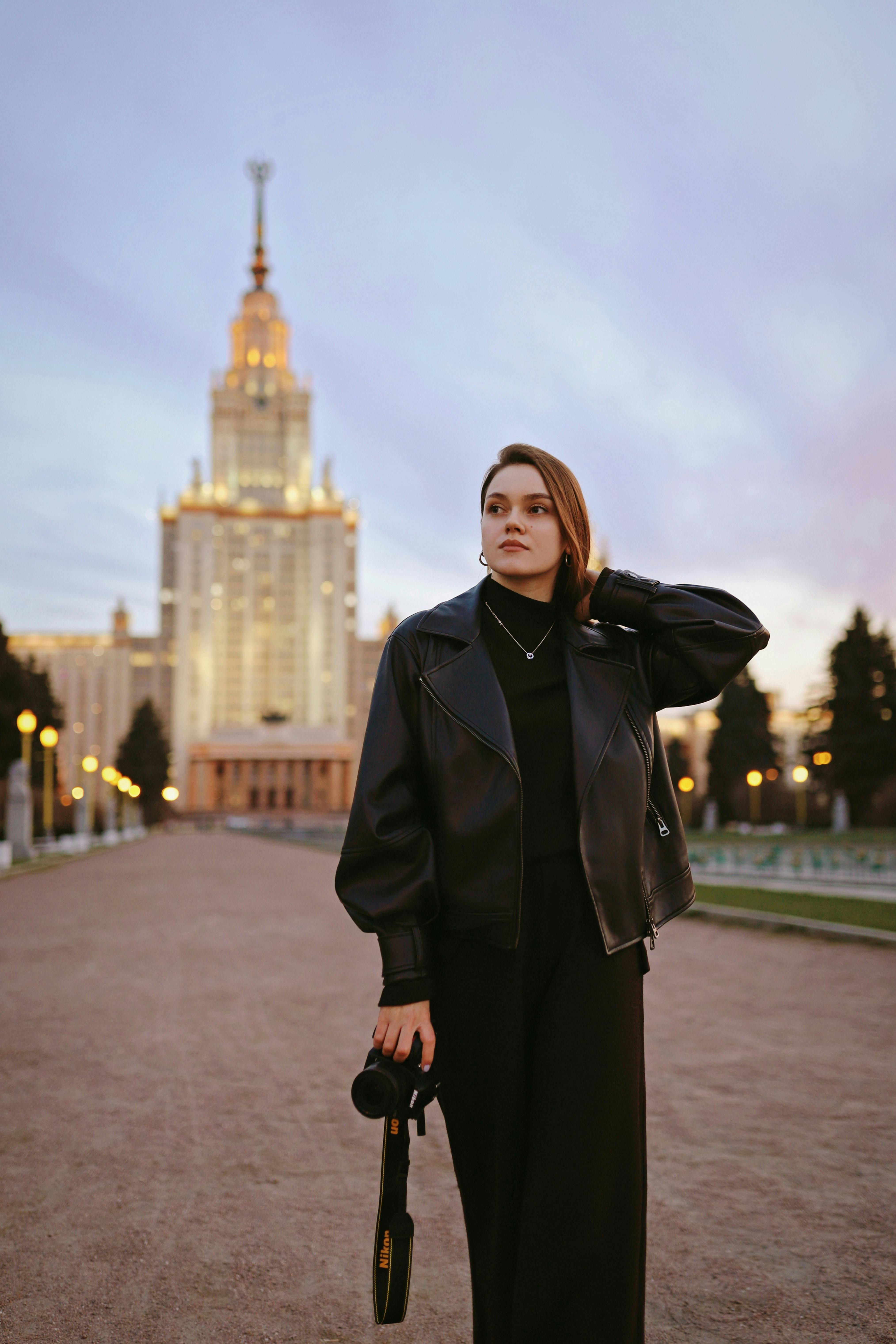 Woman in Leather Clothes in Corner of Warehouse · Free Stock Photo