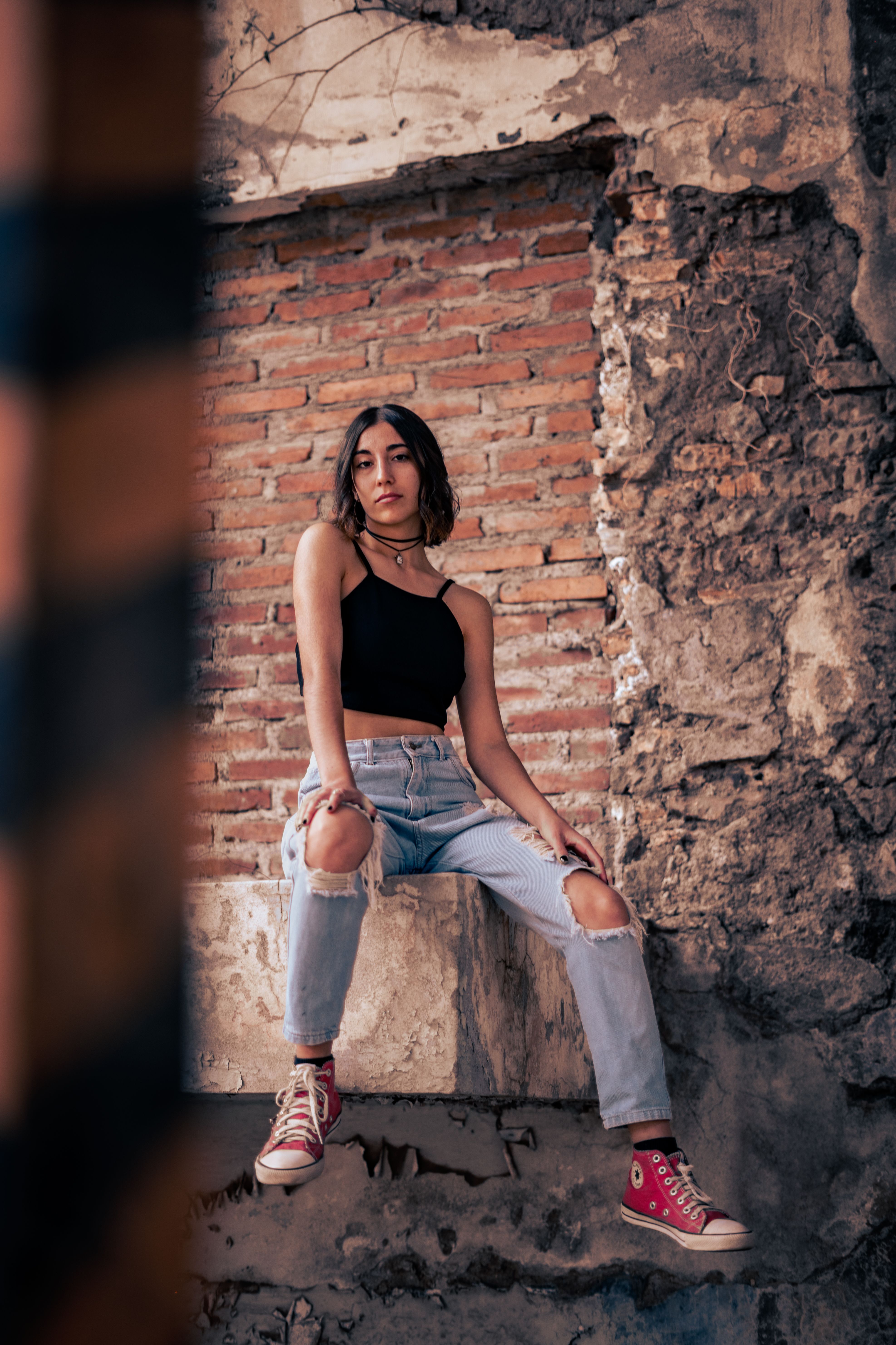 Model Sitting in Skinny Jeans · Free Stock Photo