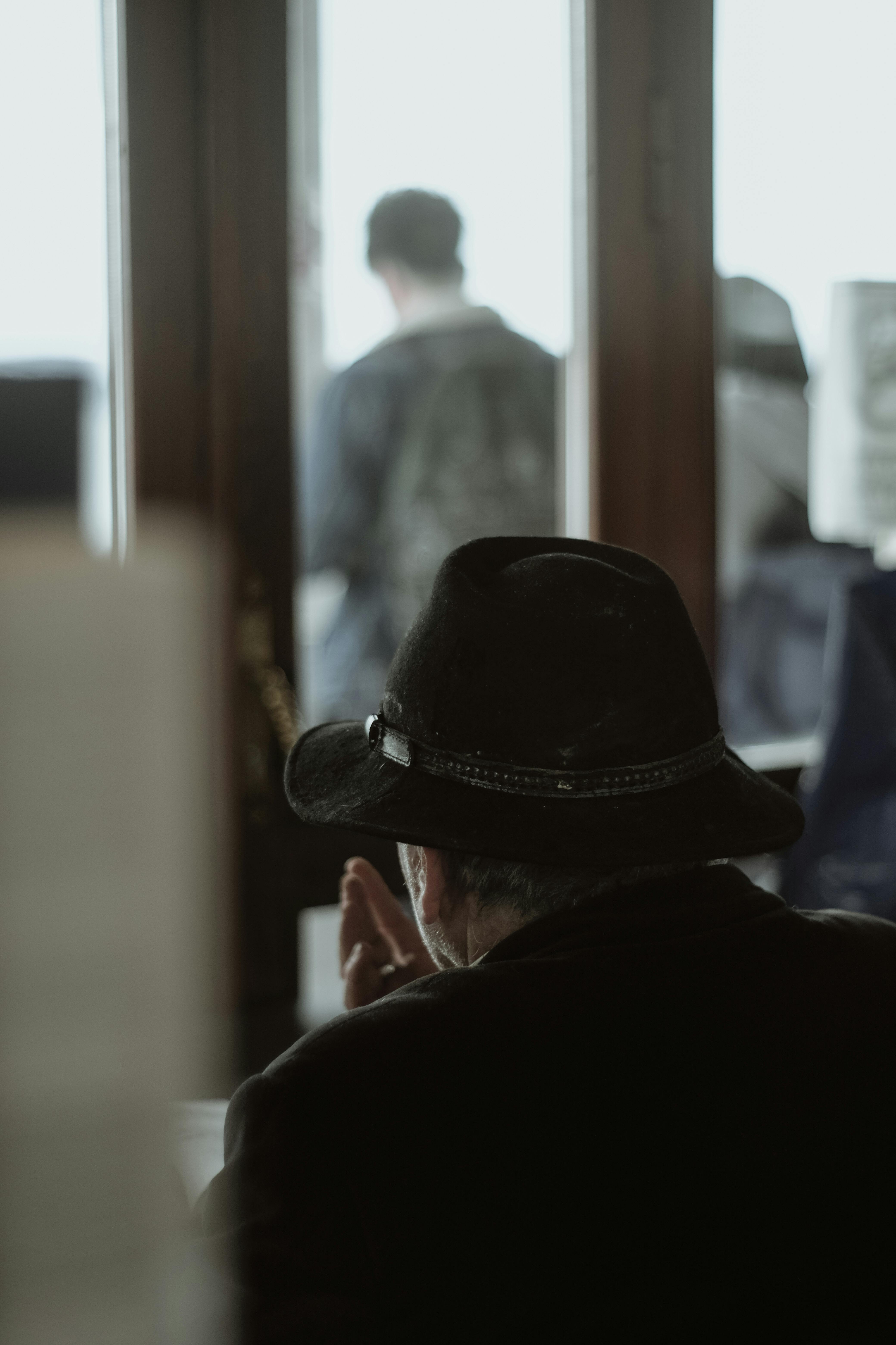 Back View of a Man Wearing a Hat, Sitting · Free Stock Photo