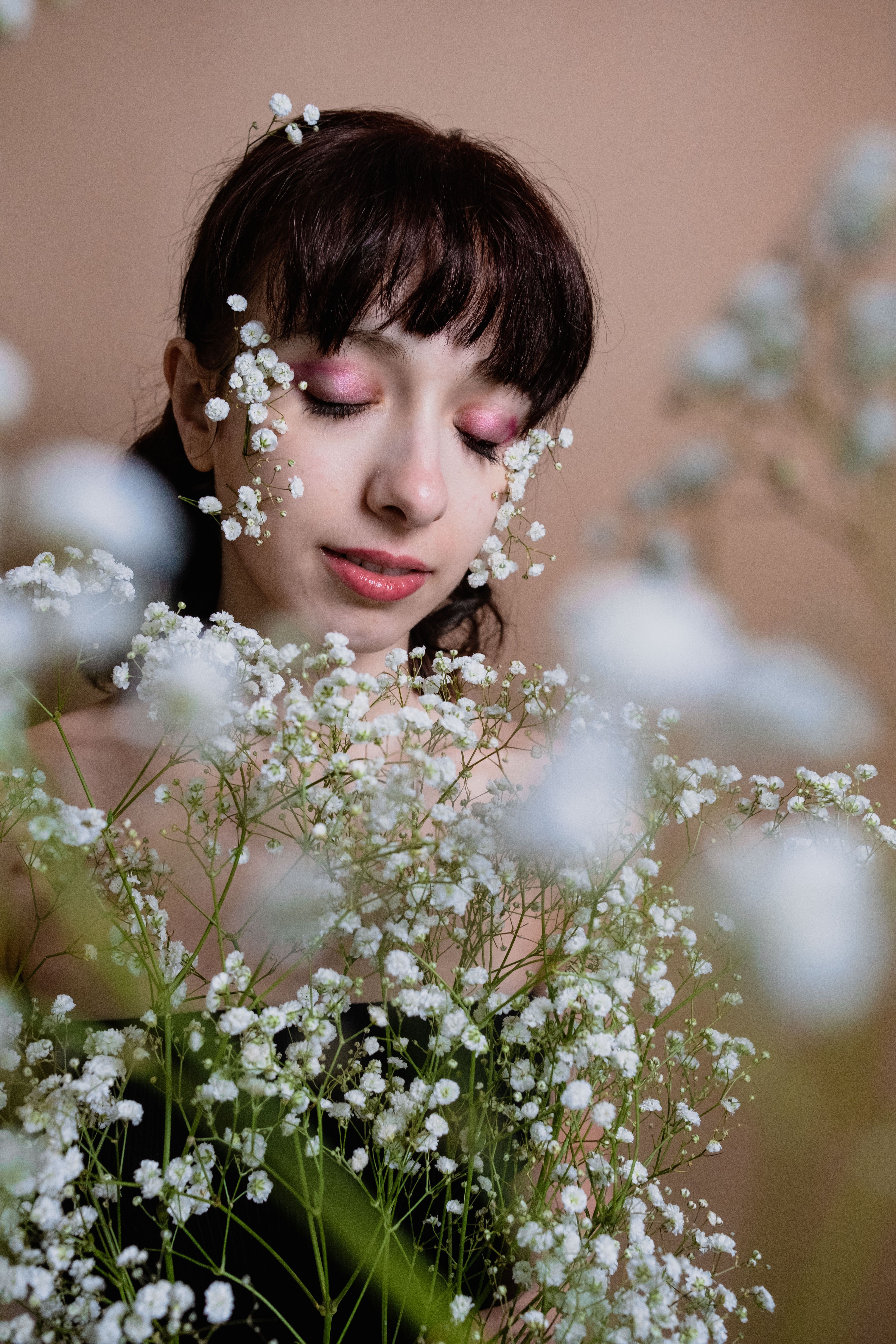 A woman with pink eyes and flowers in her hair · Free Stock Photo