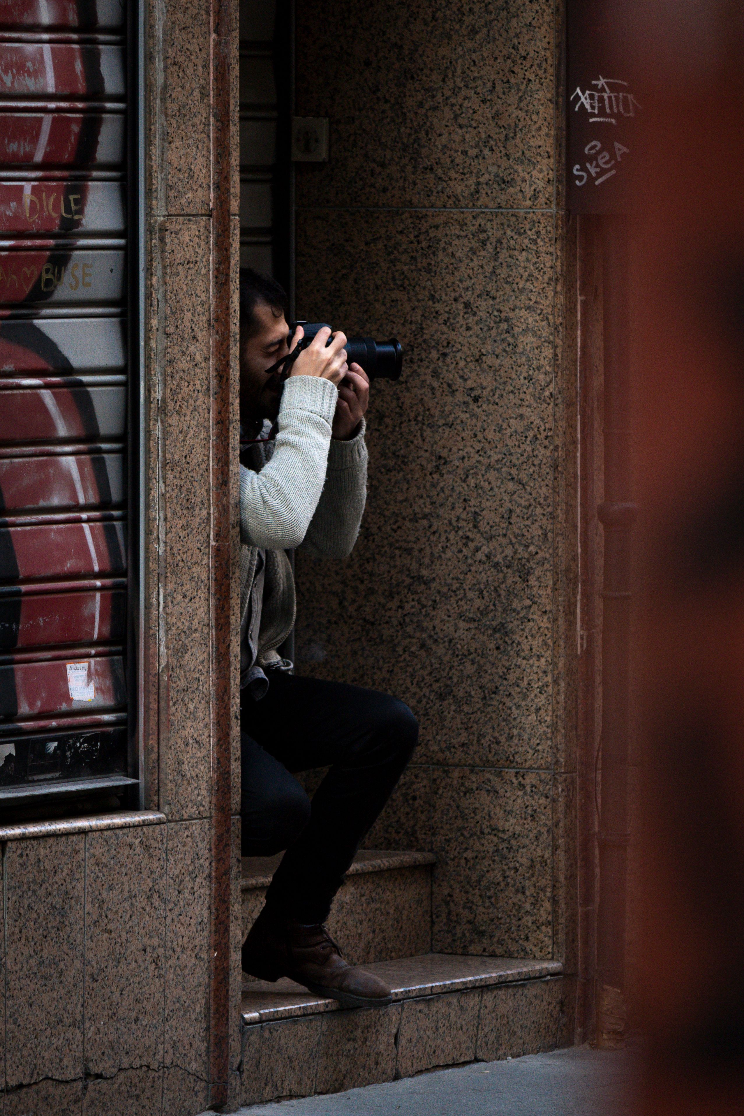 Man with camera walking down street · Free Stock Photo