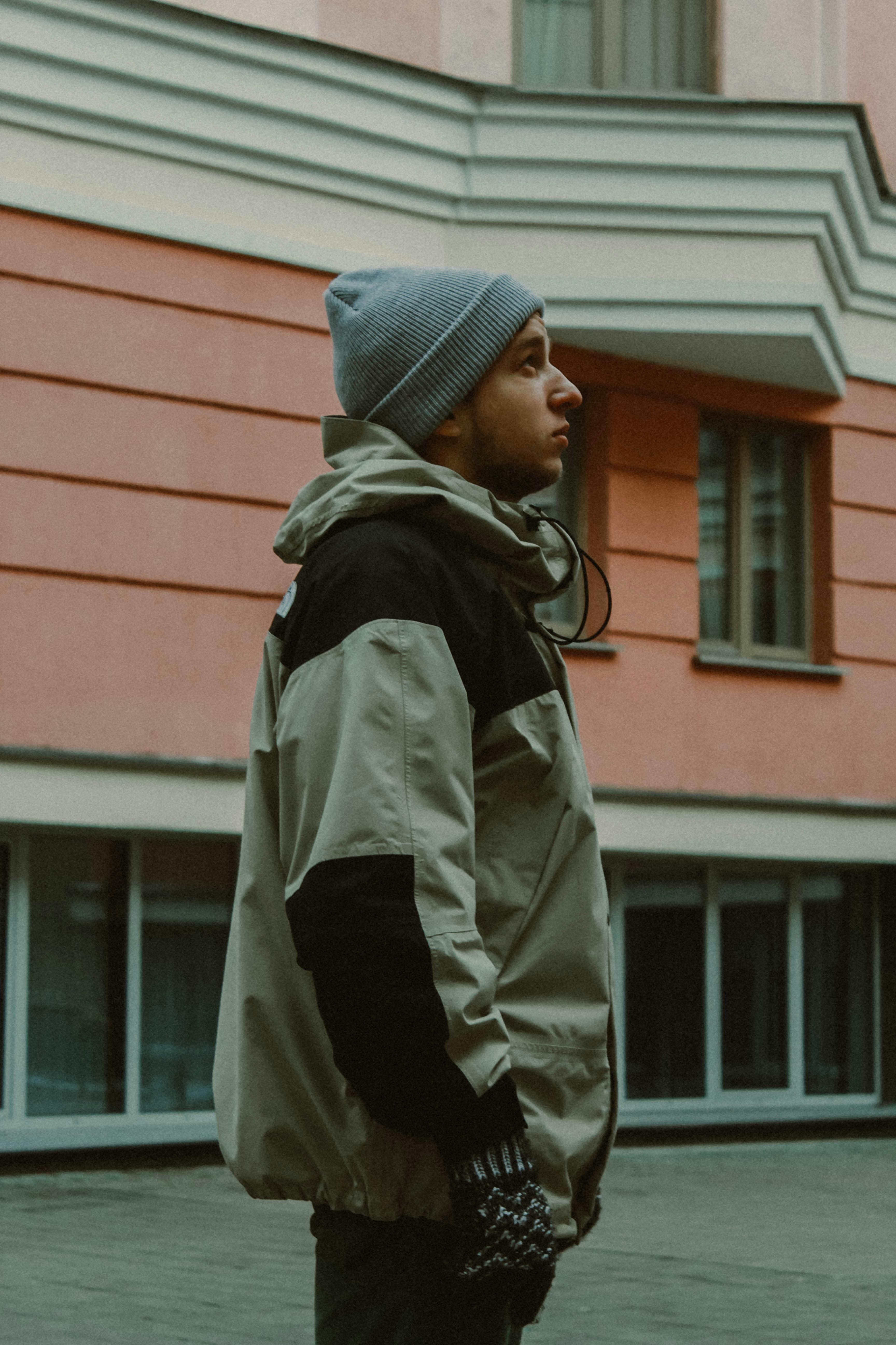 Man in Jacket Standing and Looking Up · Free Stock Photo