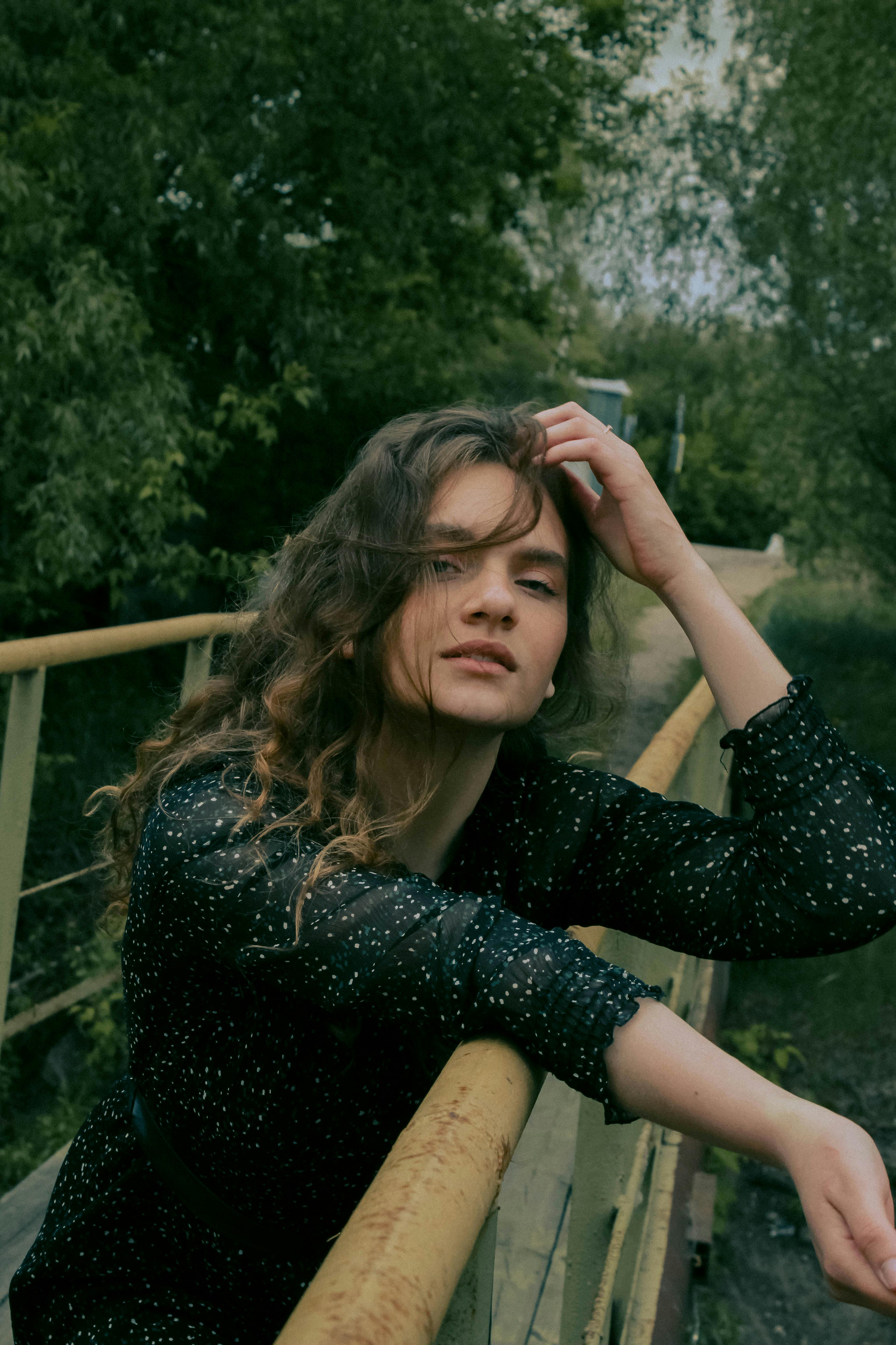 Blonde Woman Leaning on Railing and Posing · Free Stock Photo