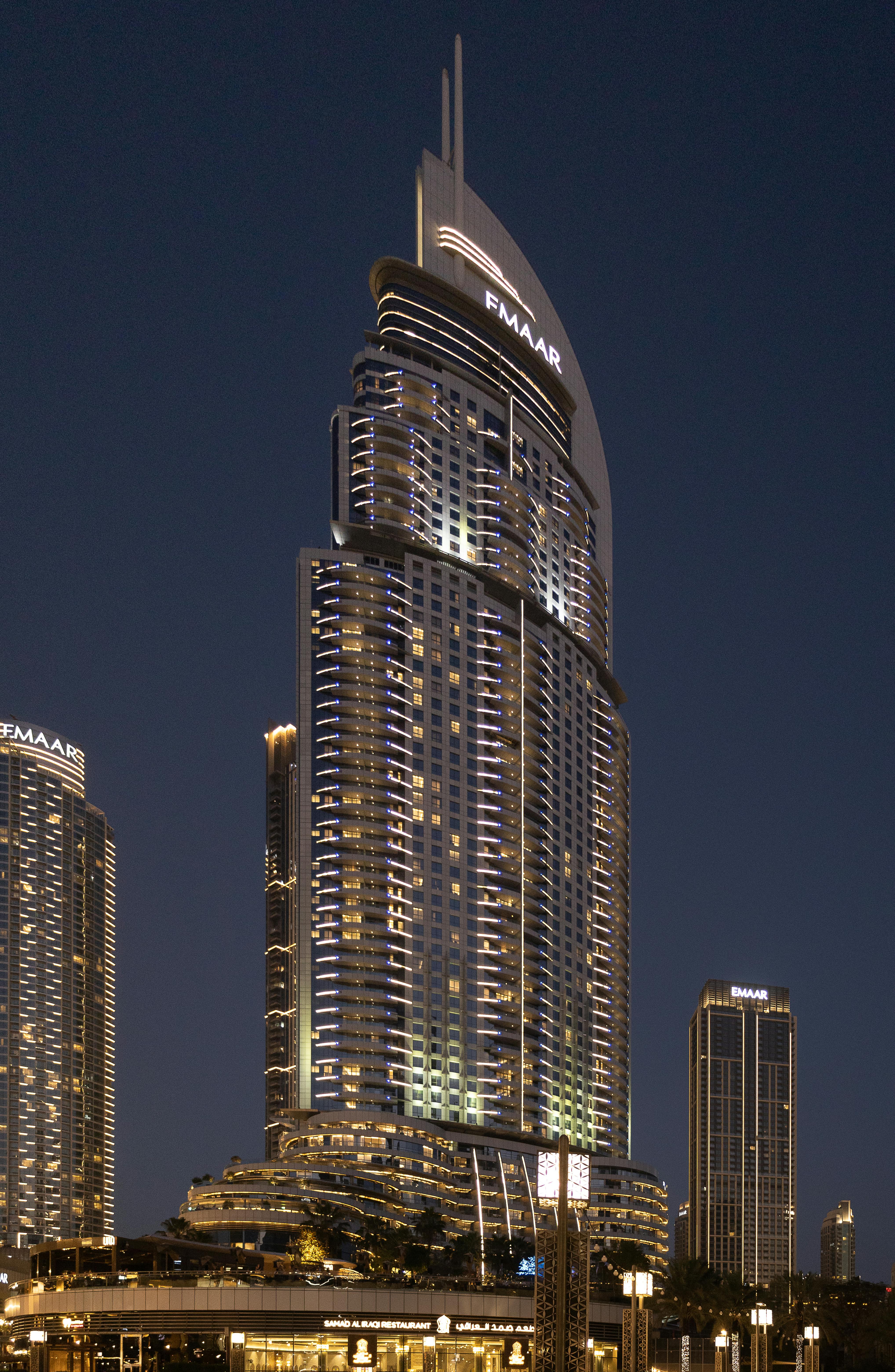 Man Standing in Assorted Building String Light during Night Time · Free ...