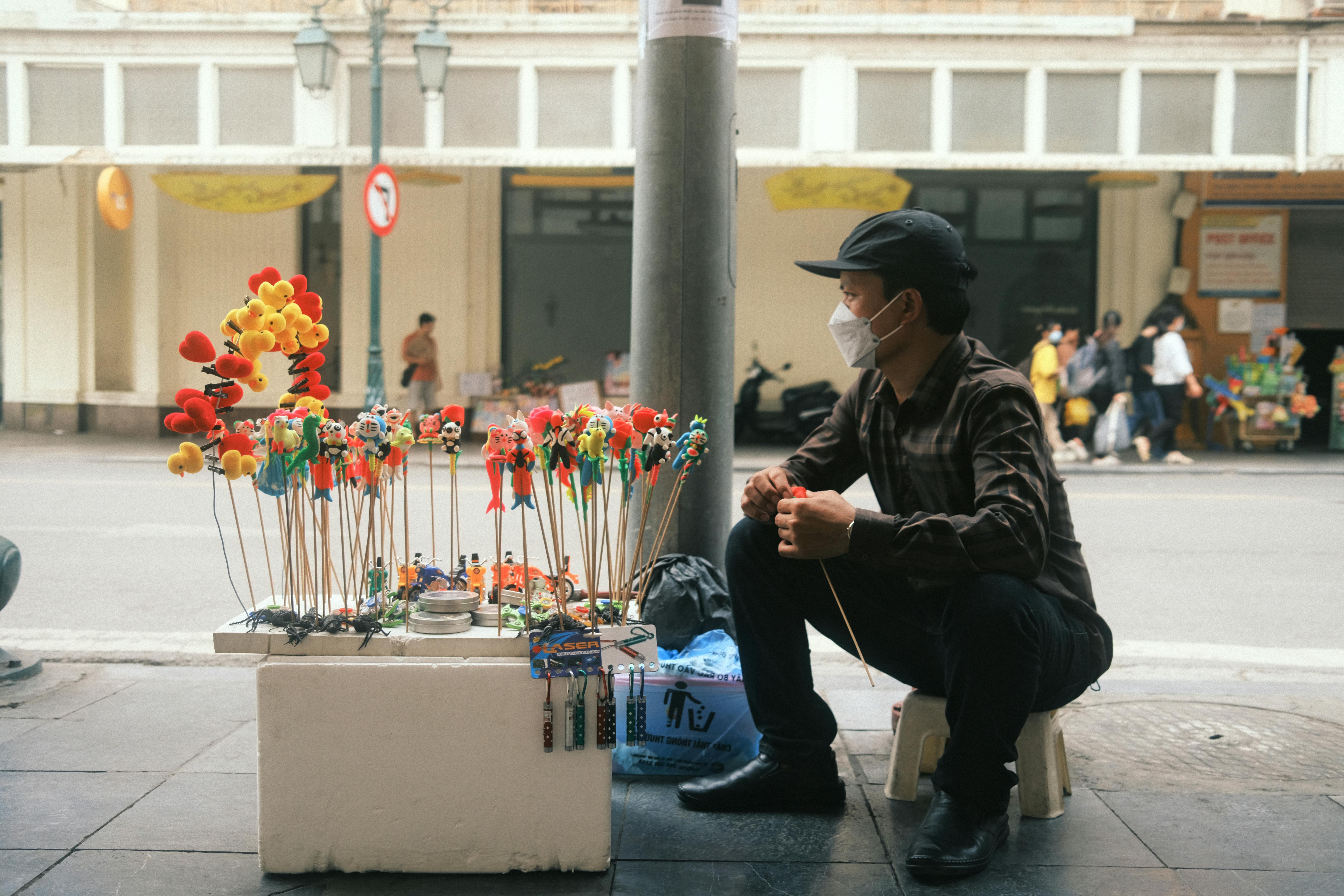Man Selling Toys on Street · Free Stock Photo