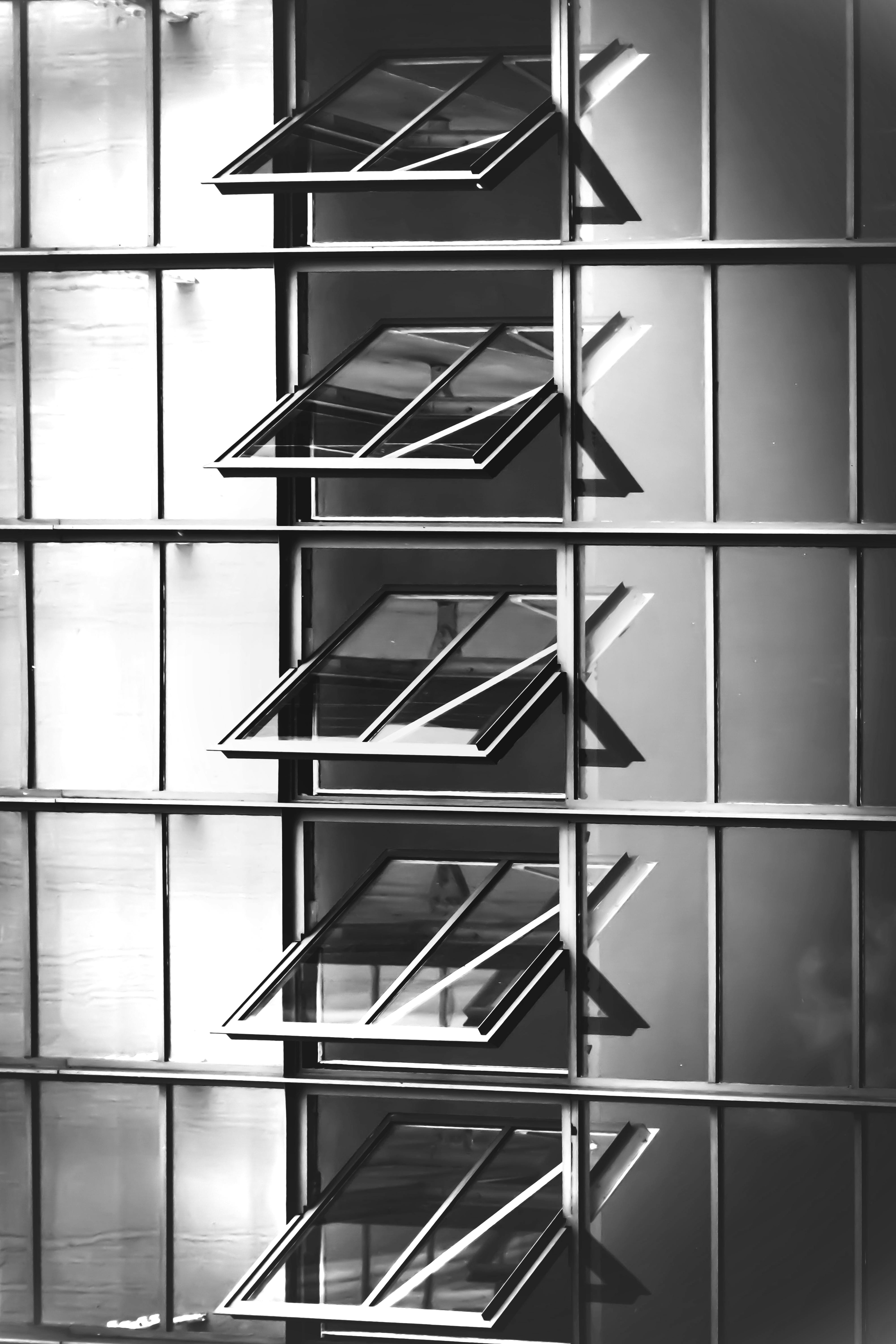 A black and white photo of a window with many windows · Free Stock Photo