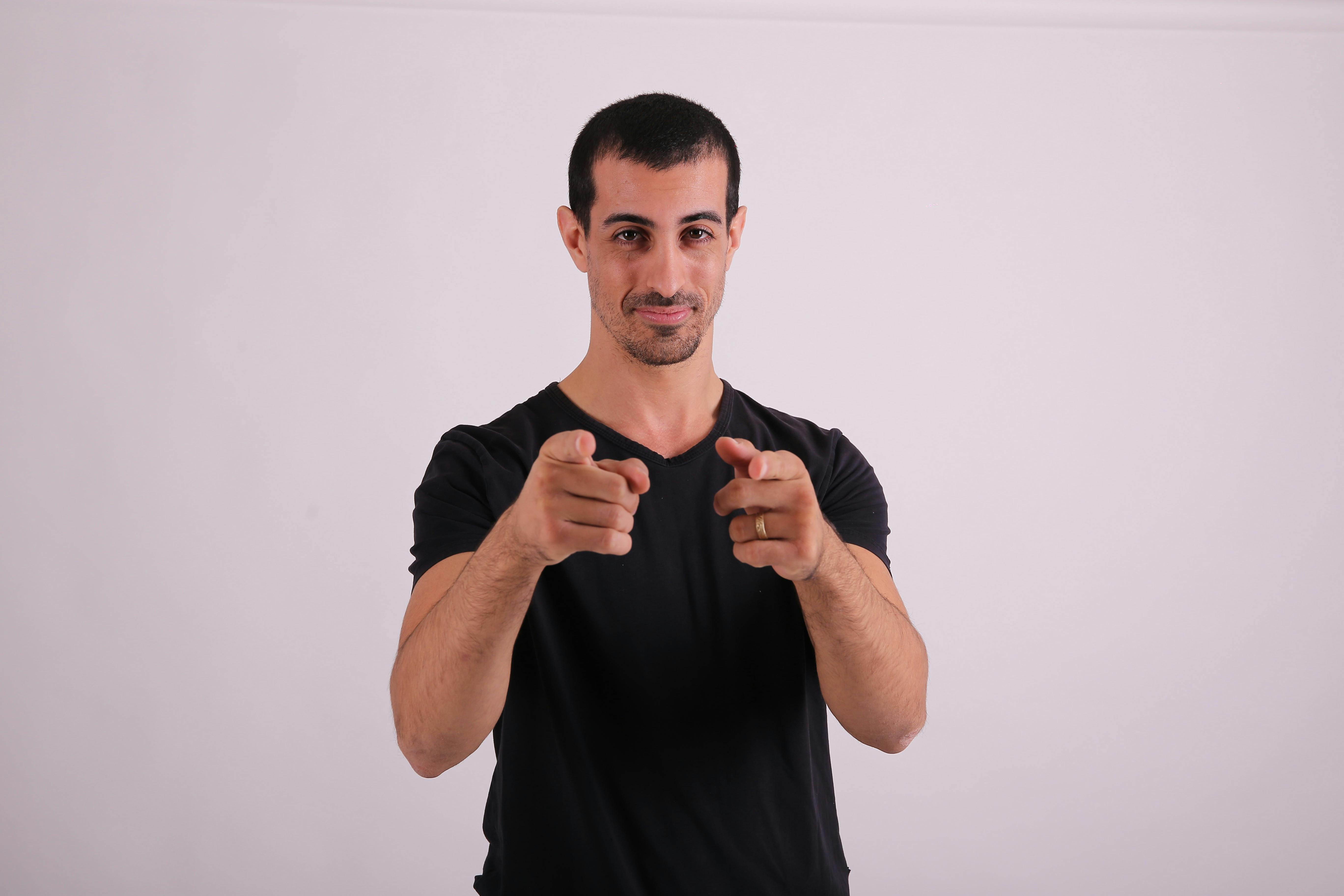Itay Verchik Smiles and points to you · Free Stock Photo