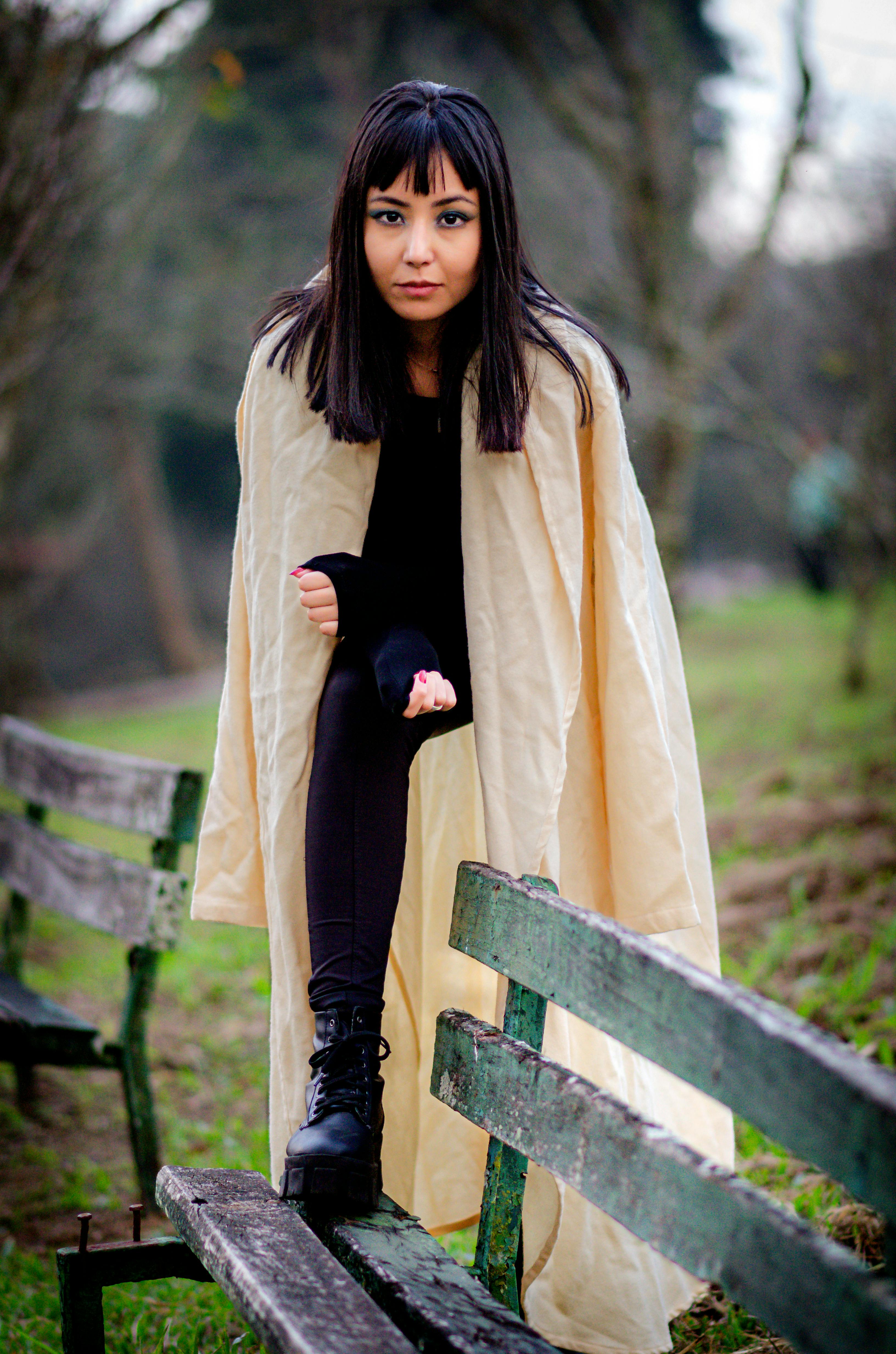Woman Leaning Leg on Park Bench · Free Stock Photo