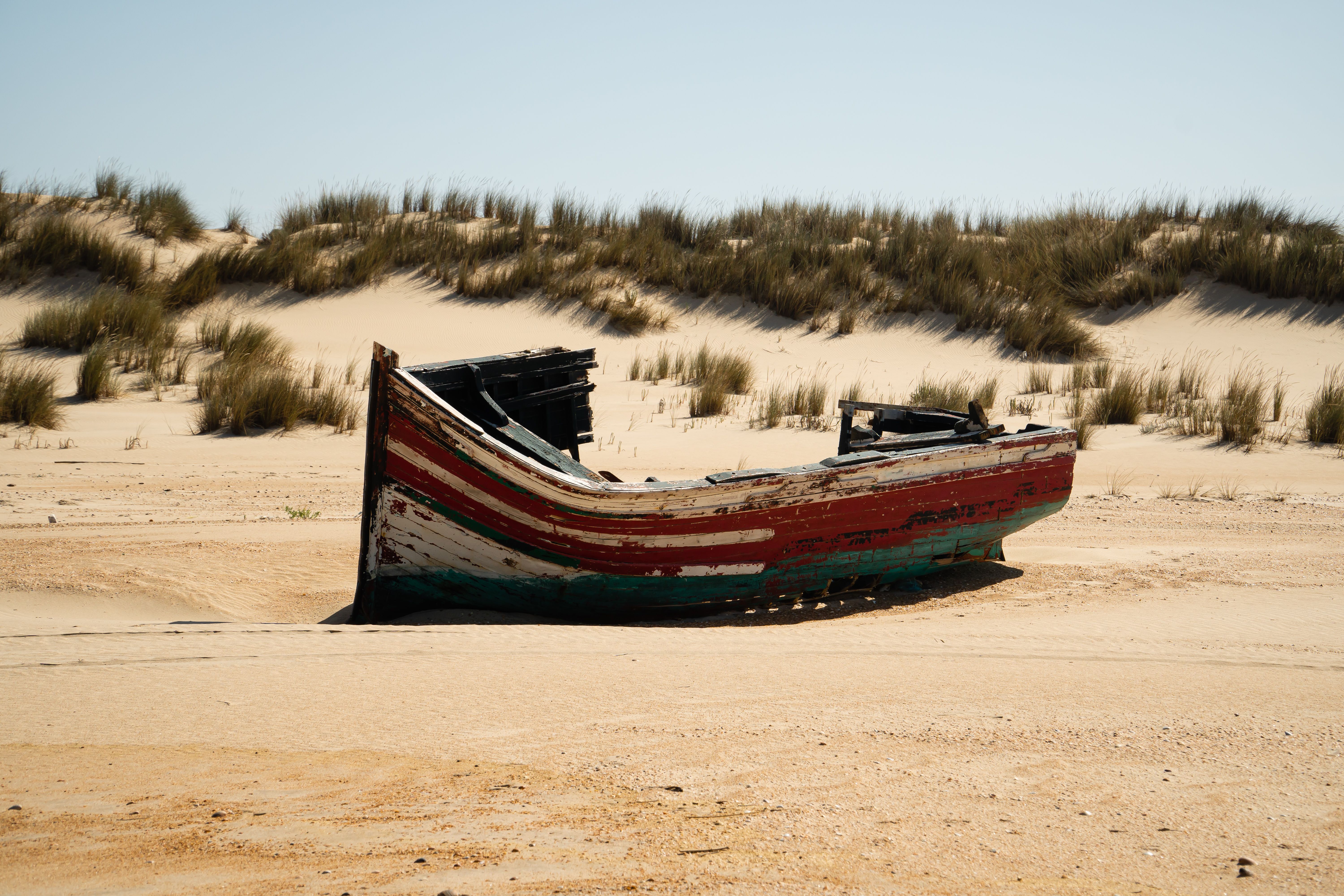 A Broken Wooden Boat on the Beach · Free Stock Photo