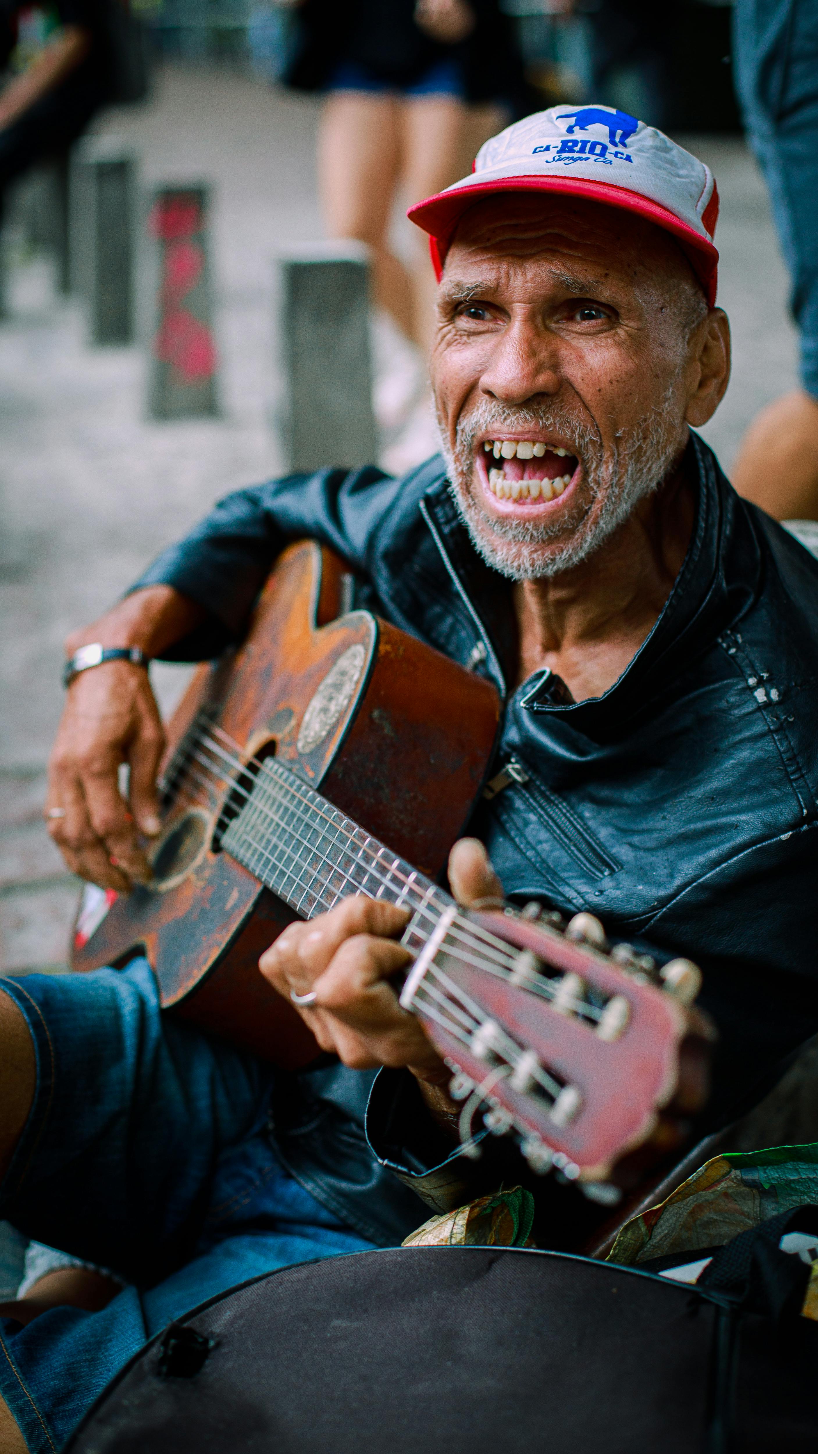 Old Man Playing Guitar on City Street · Free Stock Photo