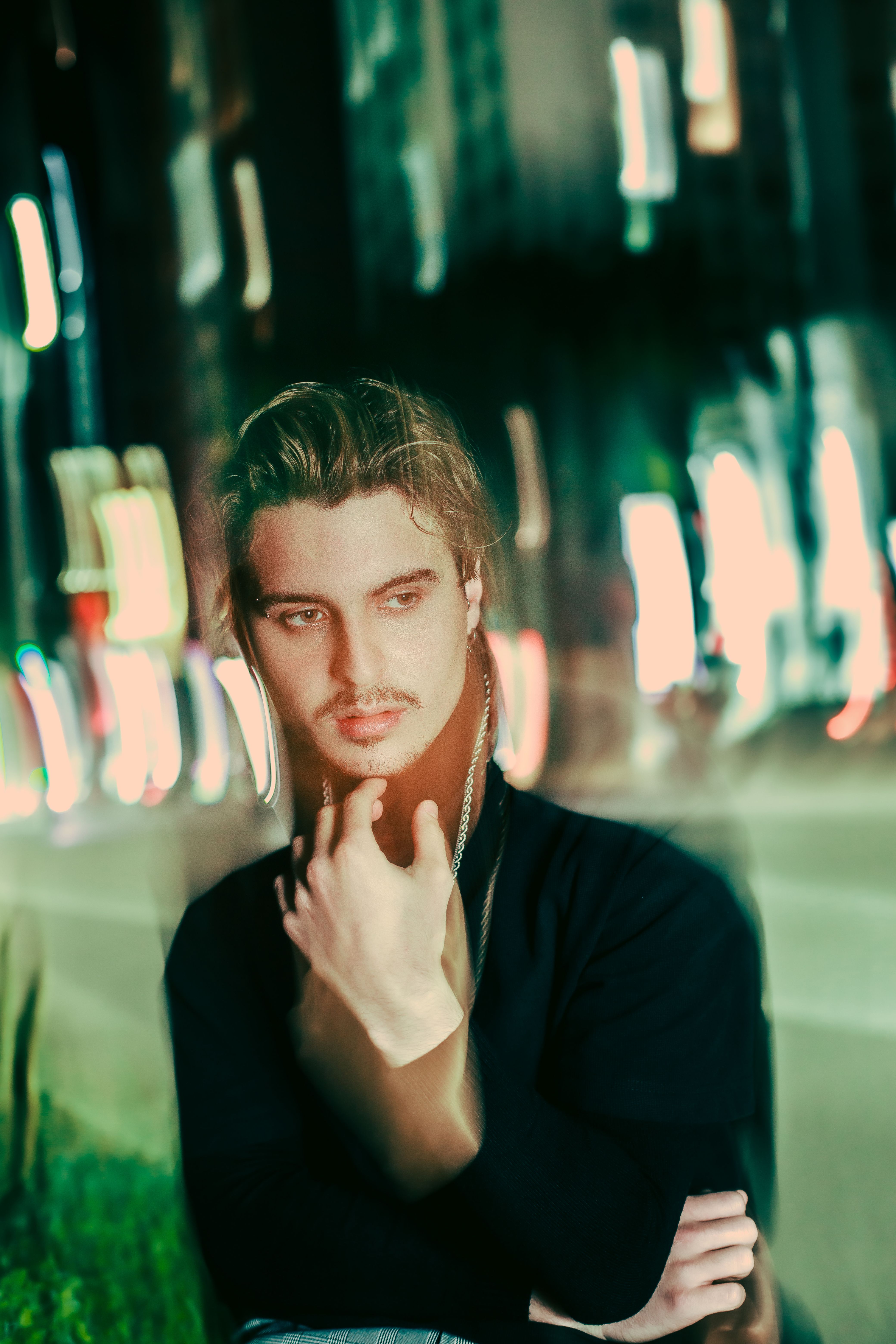 Blurred Photo of a Young Man and Blurred City Lights · Free Stock Photo