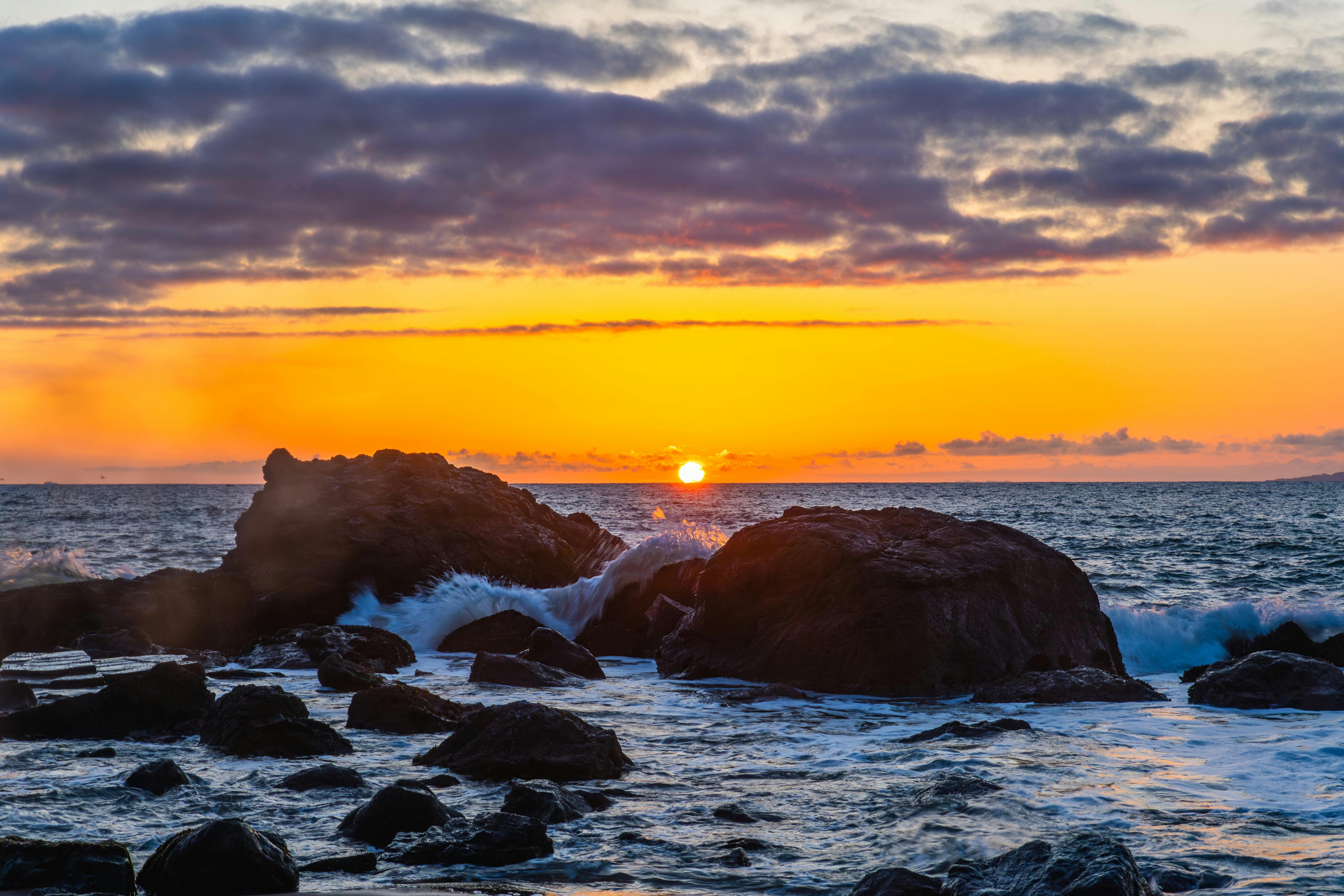 Sunset over Rocks on Sea Shore · Free Stock Photo