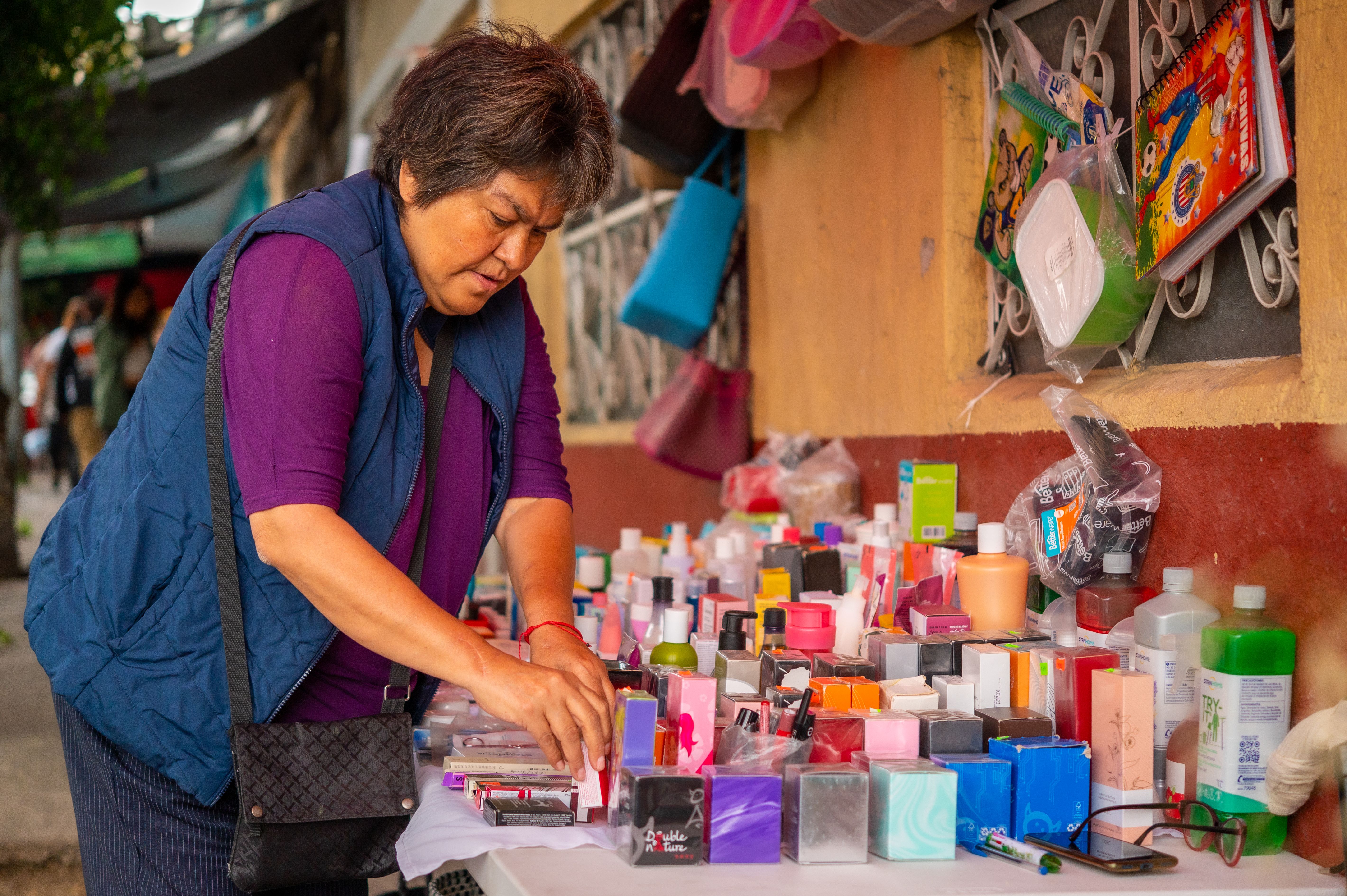 Woman Looking at Cosmetics at a Market Stall · Free Stock Photo