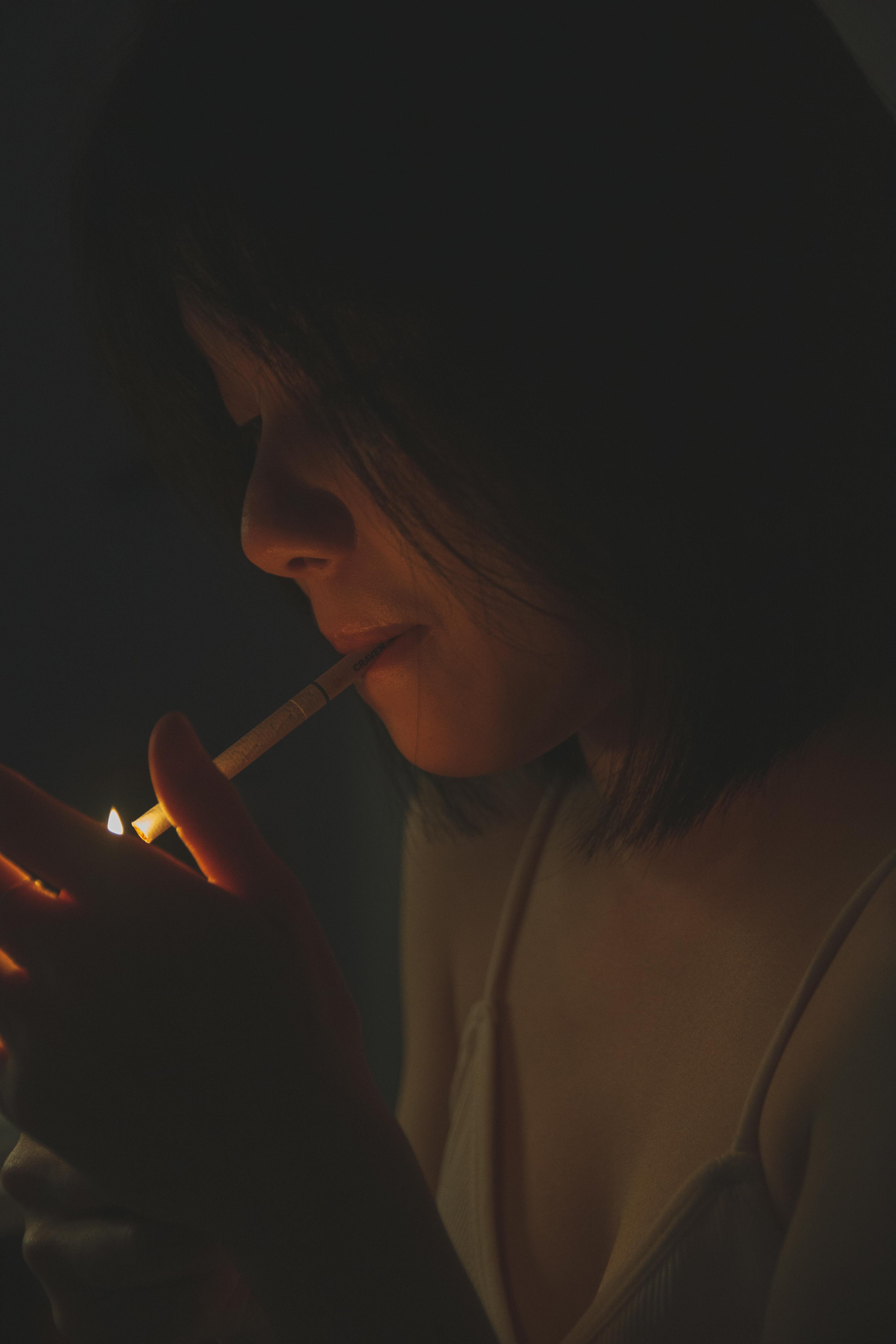 Woman Lighting Cigarette at Night · Free Stock Photo