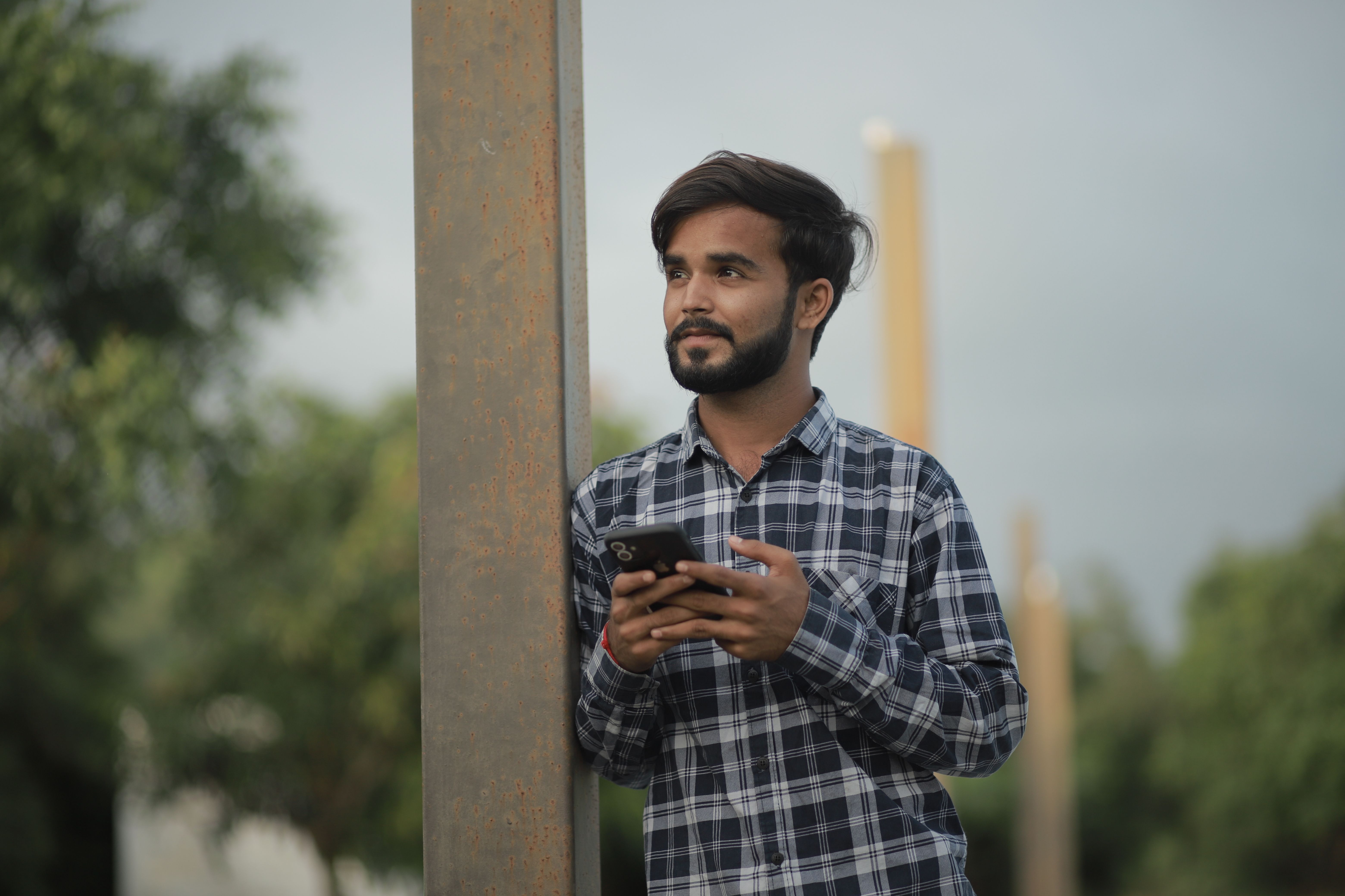 Man Wearing a Checked Shirt in a Park · Free Stock Photo