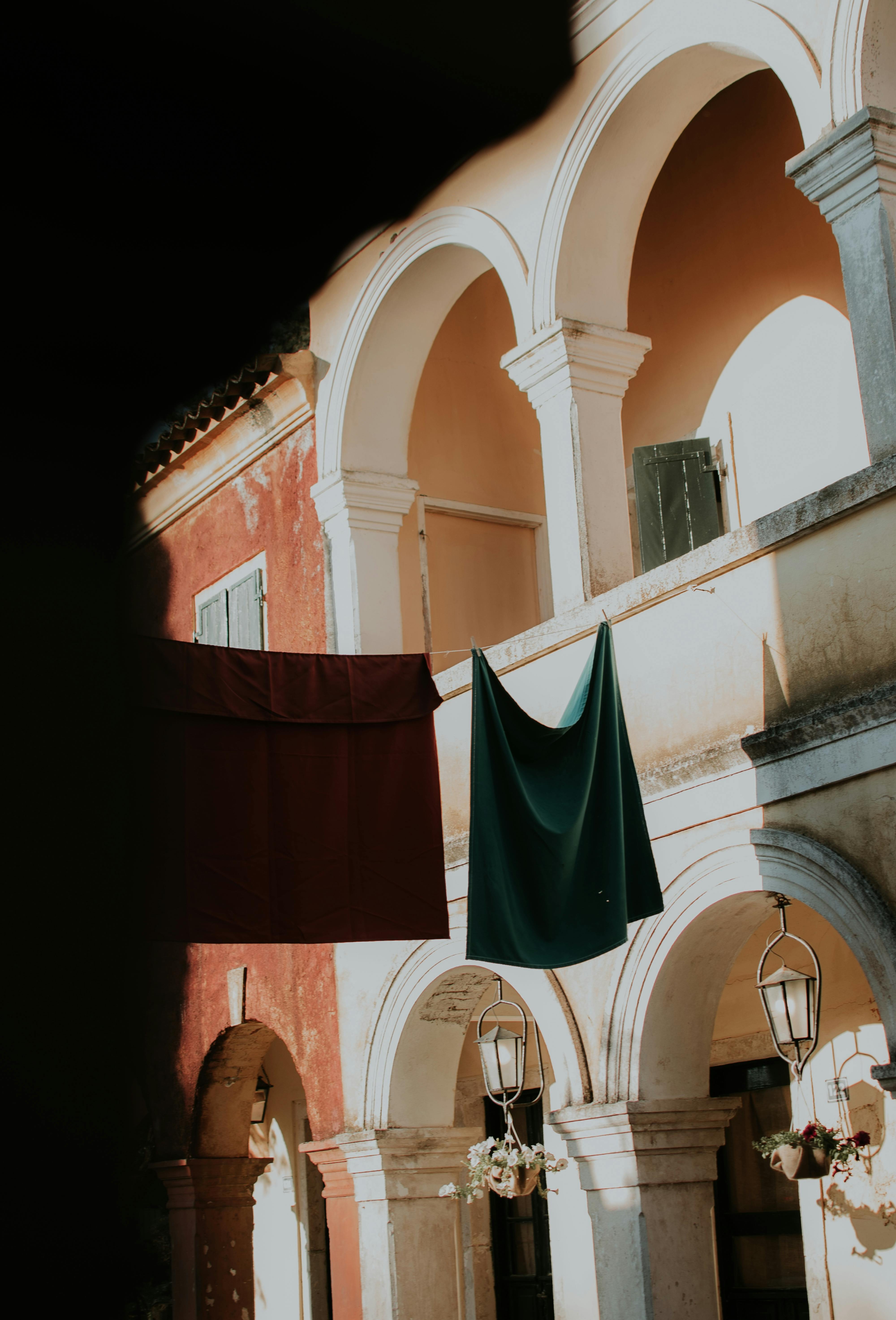 Laundry Drying between Arches · Free Stock Photo