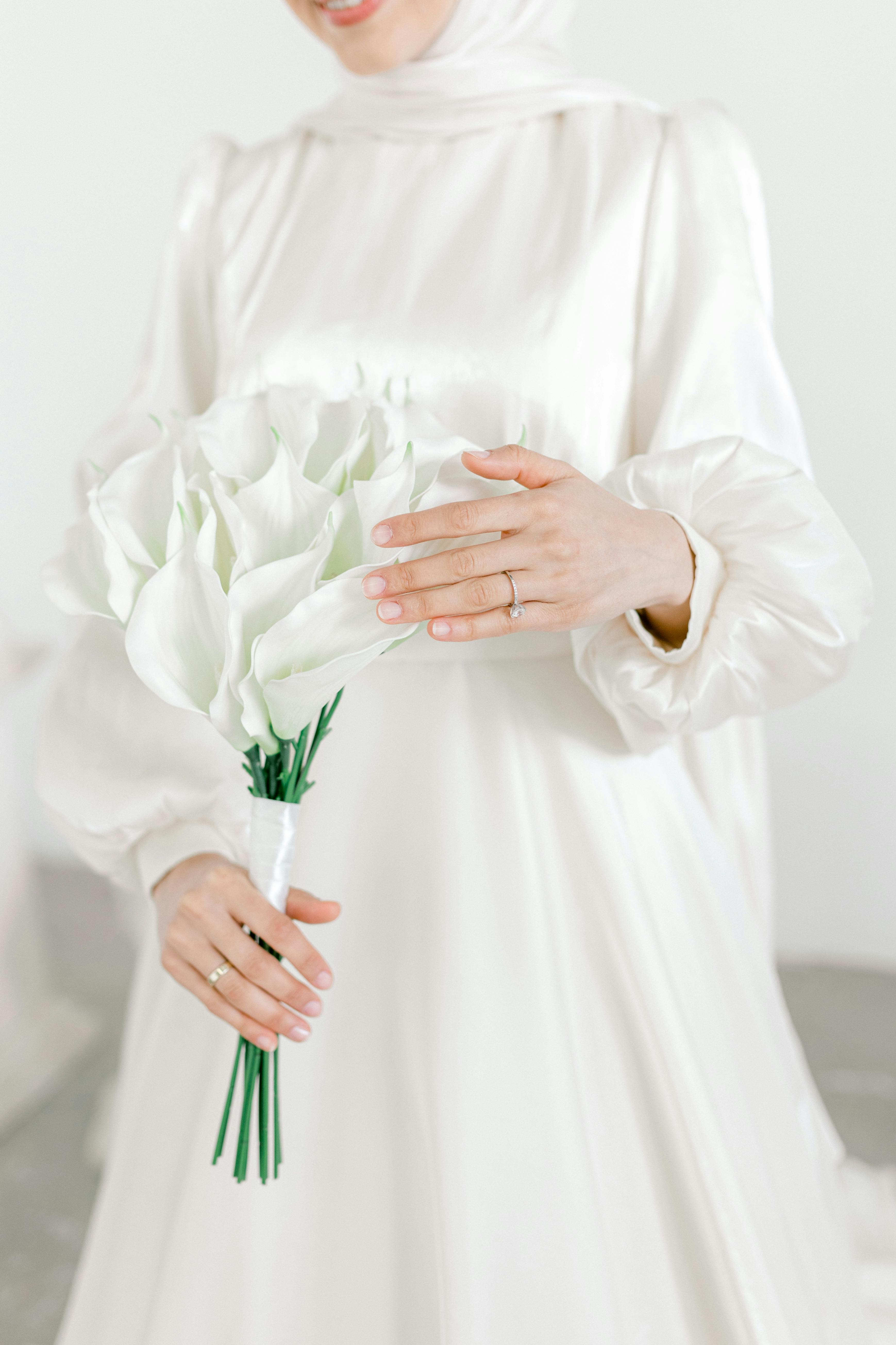Woman in a White Dress Holding a Bouquet · Free Stock Photo
