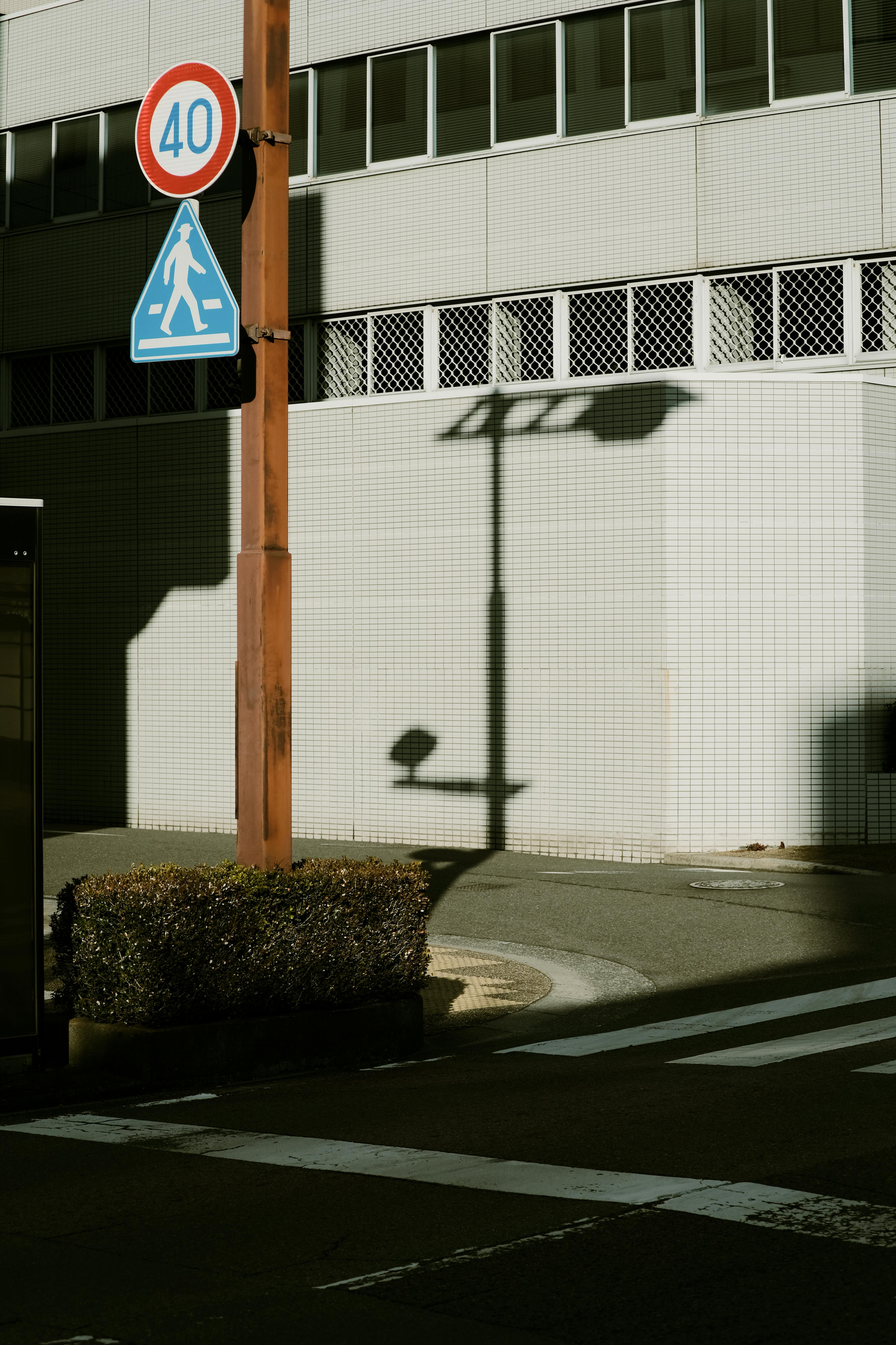 Street Lamp Casting Shadow on Building Wall on Street Corner · Free ...
