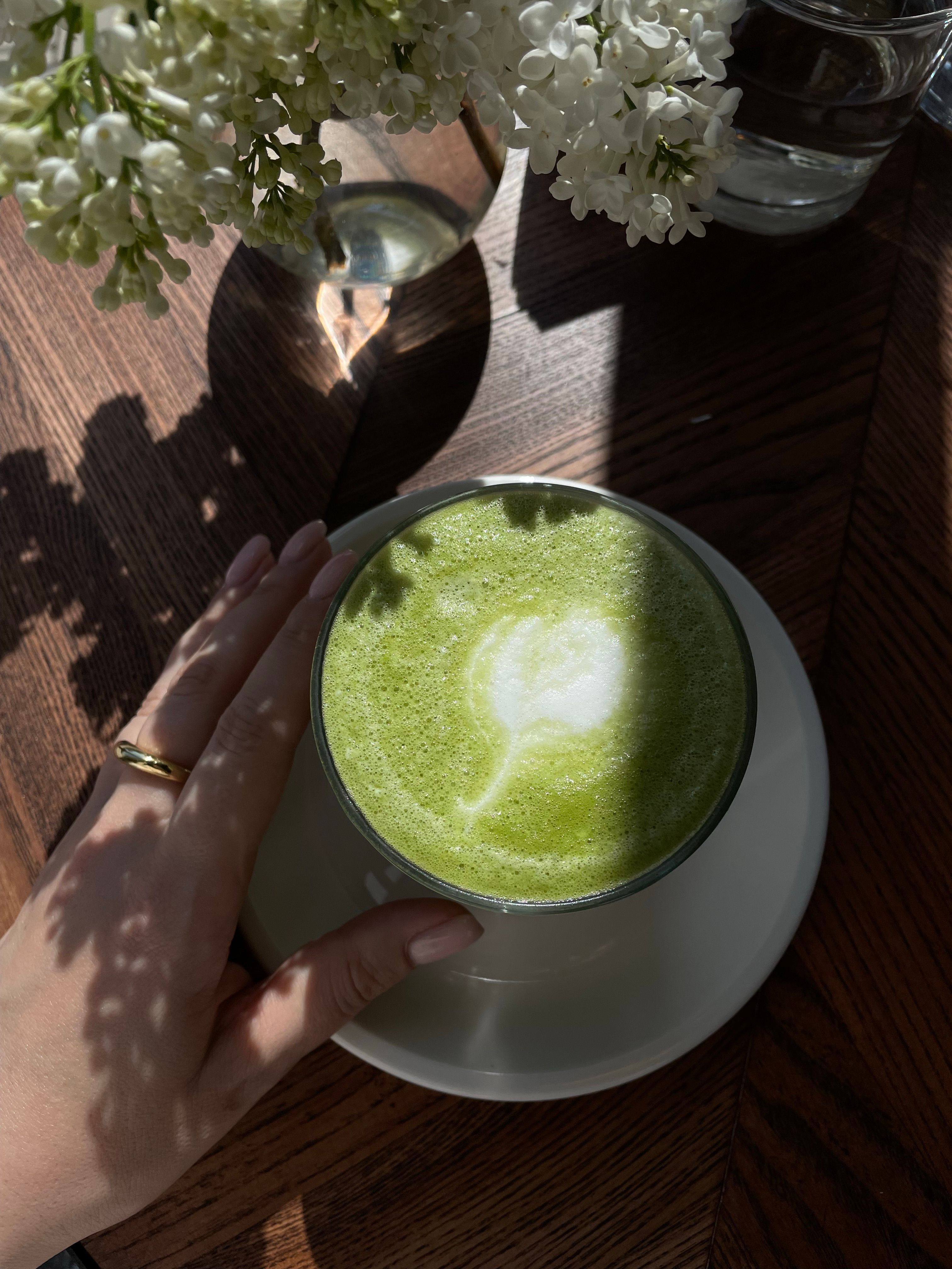 Photo of a Person's Hand Holding a Cup with Matcha Latte · Free Stock Photo