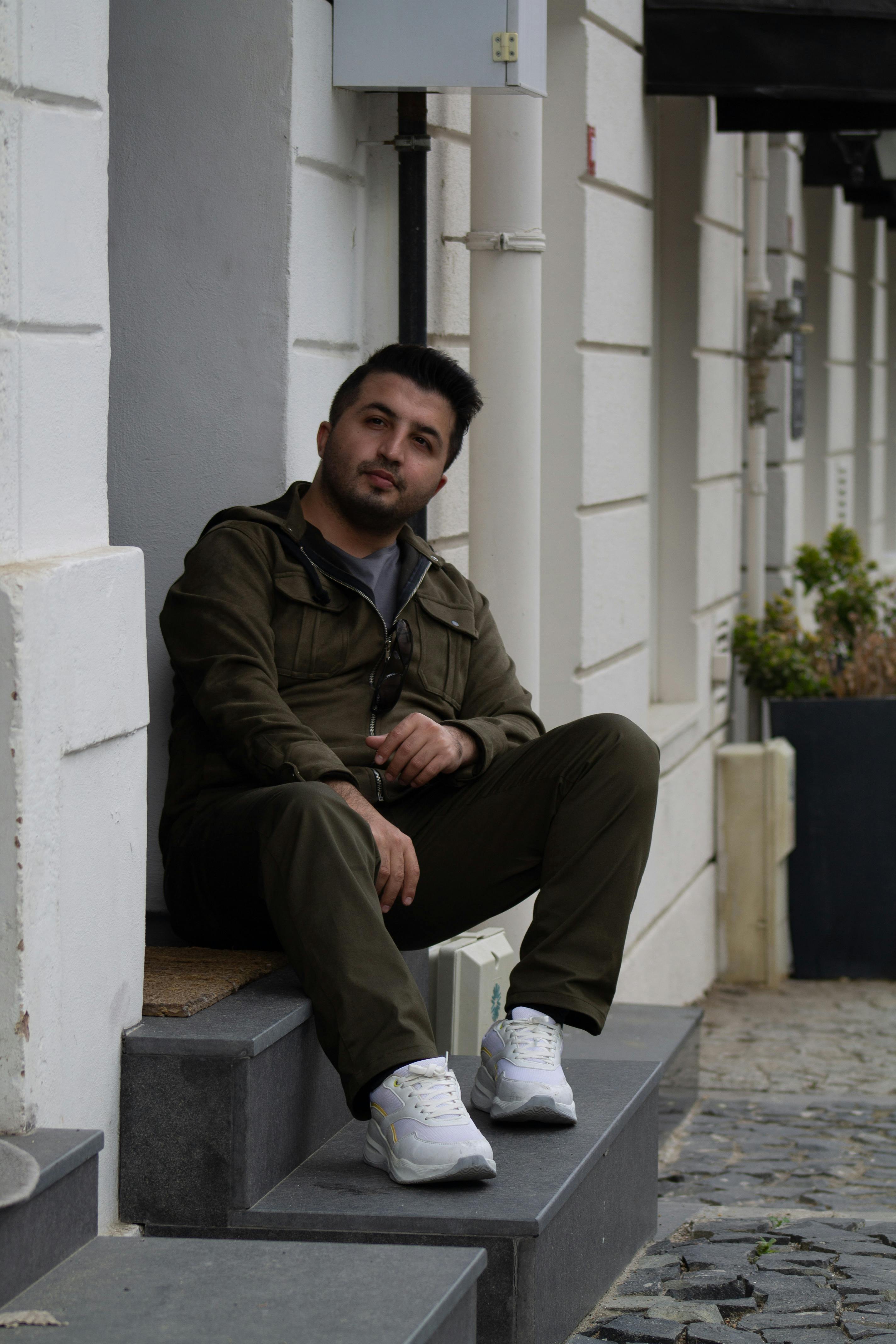 Man Sitting on Step in front of House Entrance · Free Stock Photo