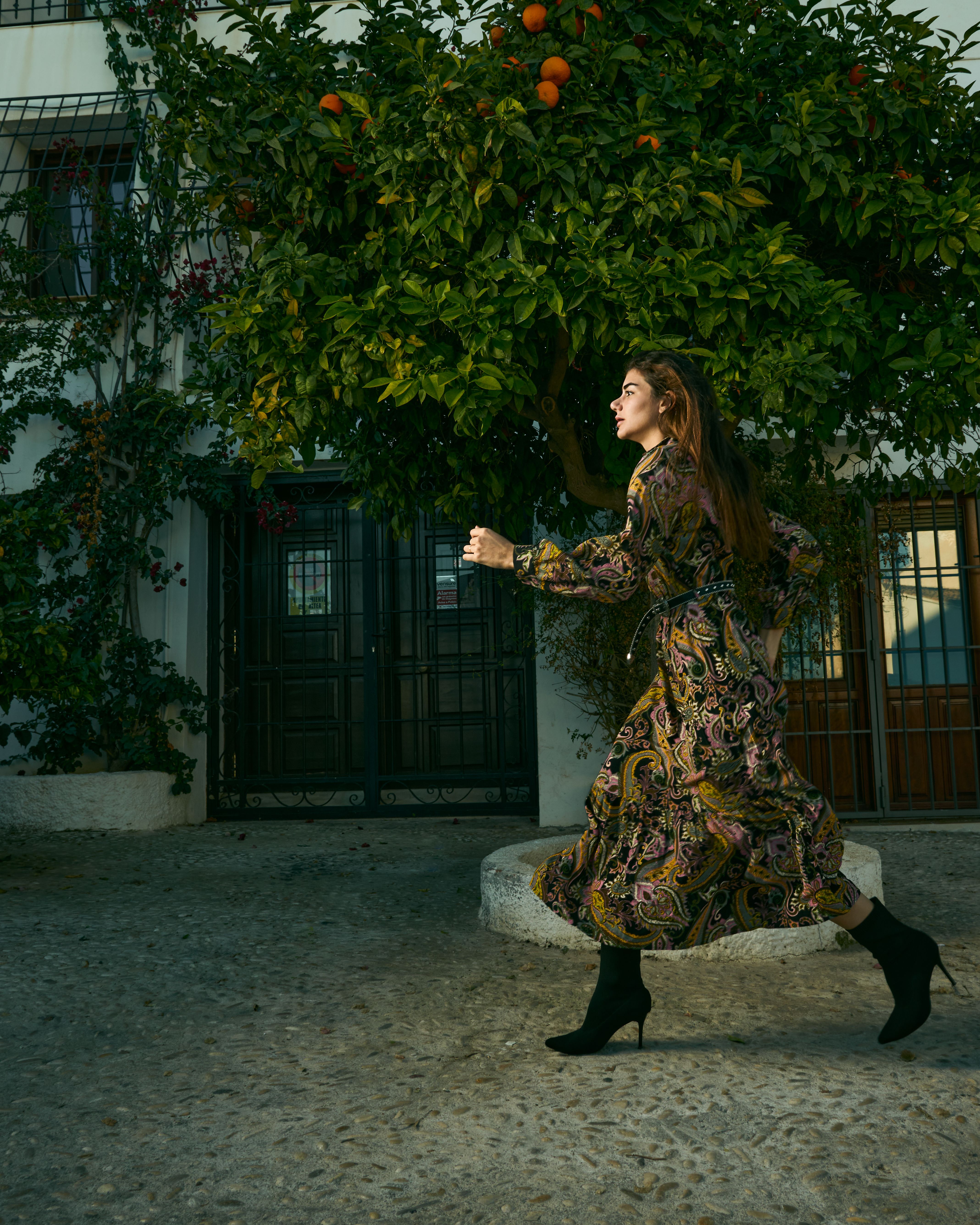 Woman in High Heels Running near Orange Tree · Free Stock Photo