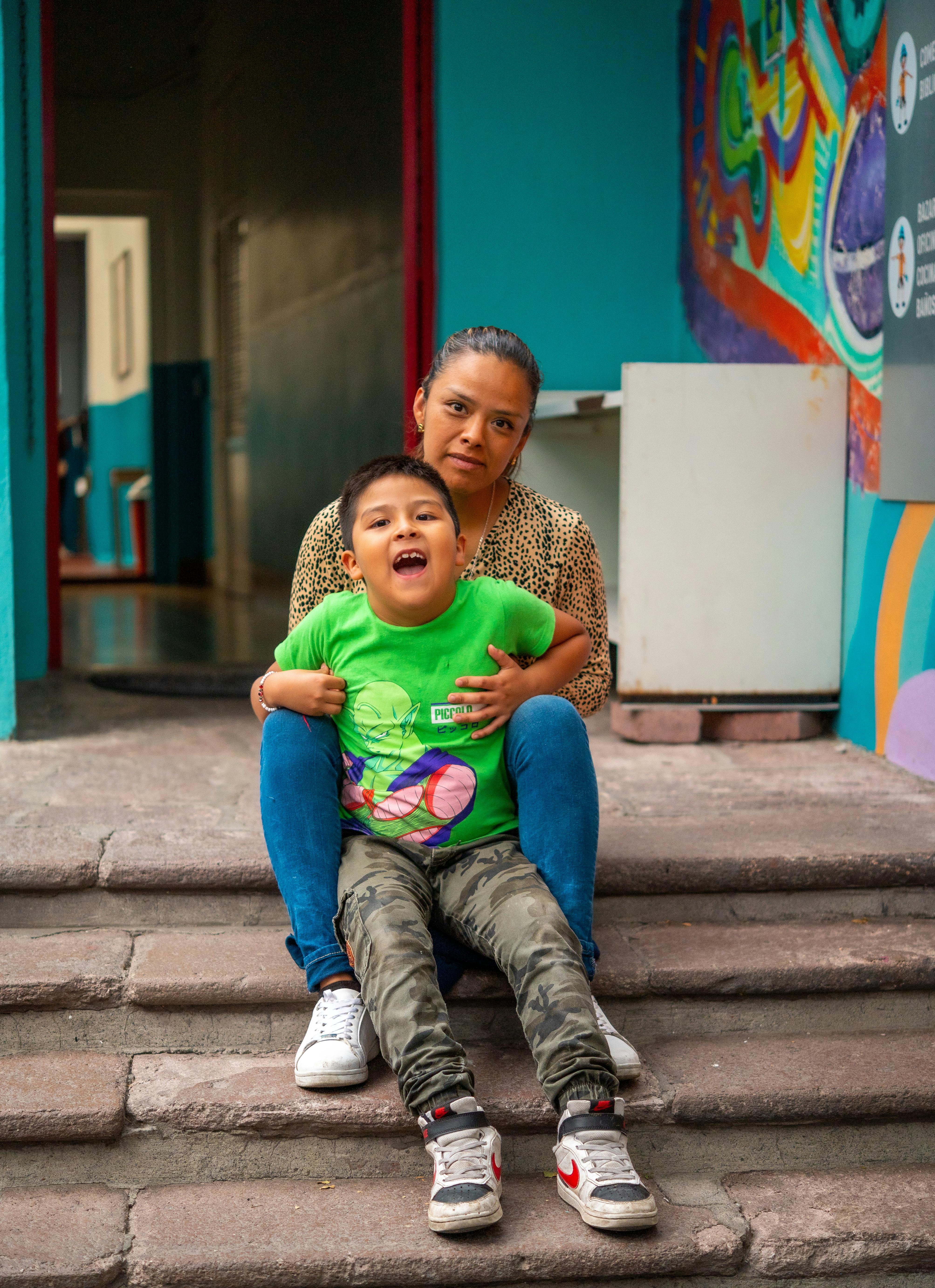 Mother Hugging Son on Stairs · Free Stock Photo