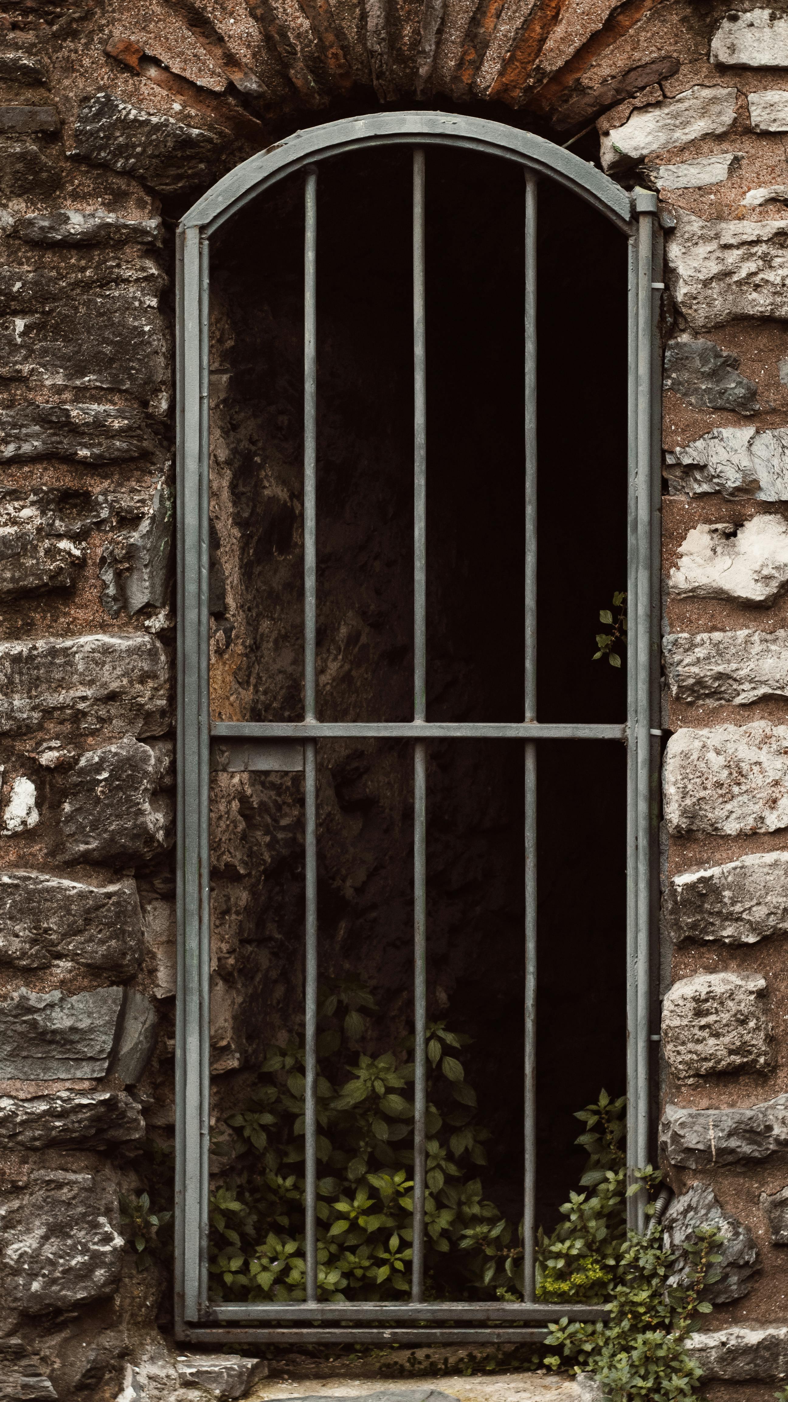 Iron Gate in the Wall of an Old Stone Building · Free Stock Photo
