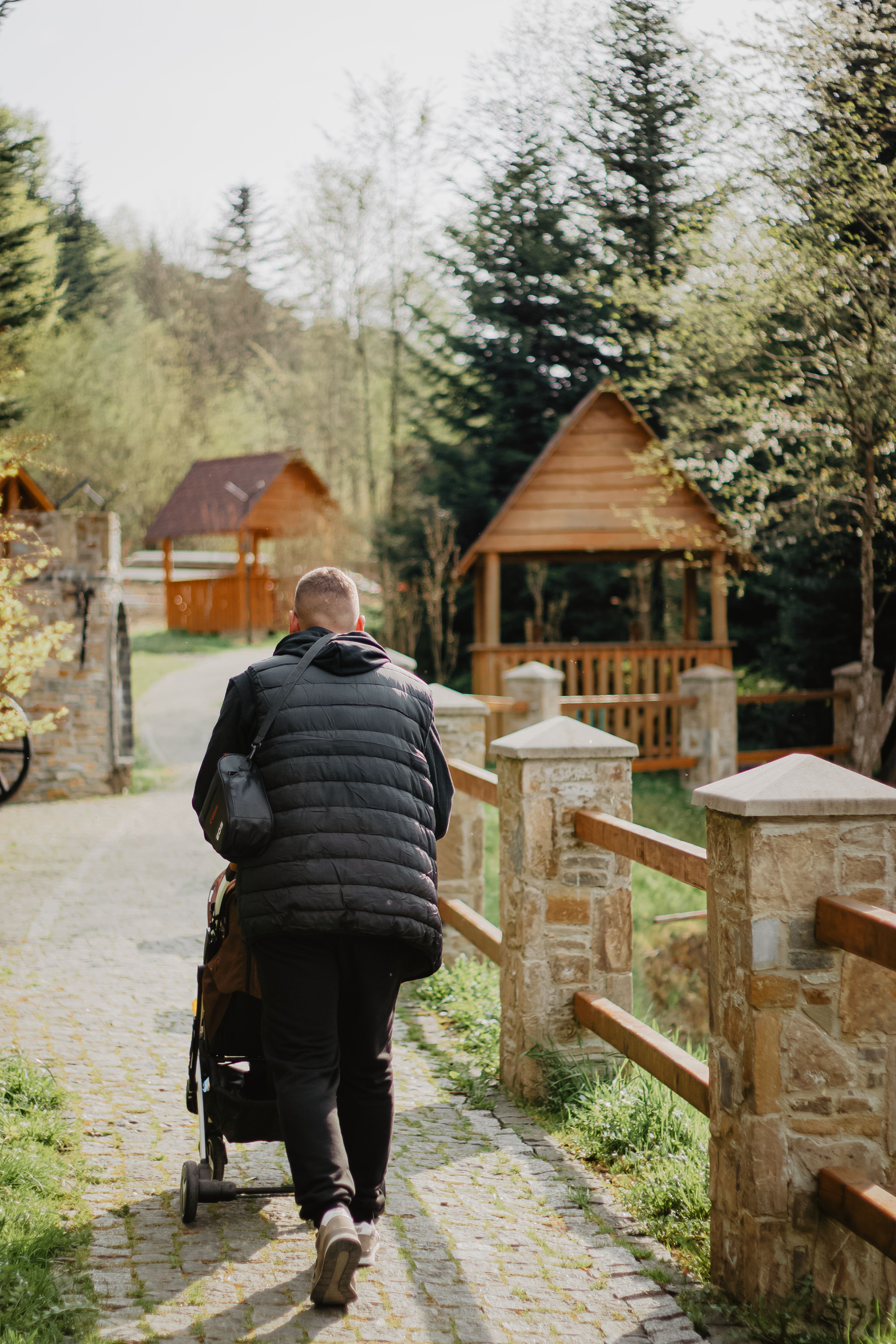 Man Pushing a Stroller · Free Stock Photo