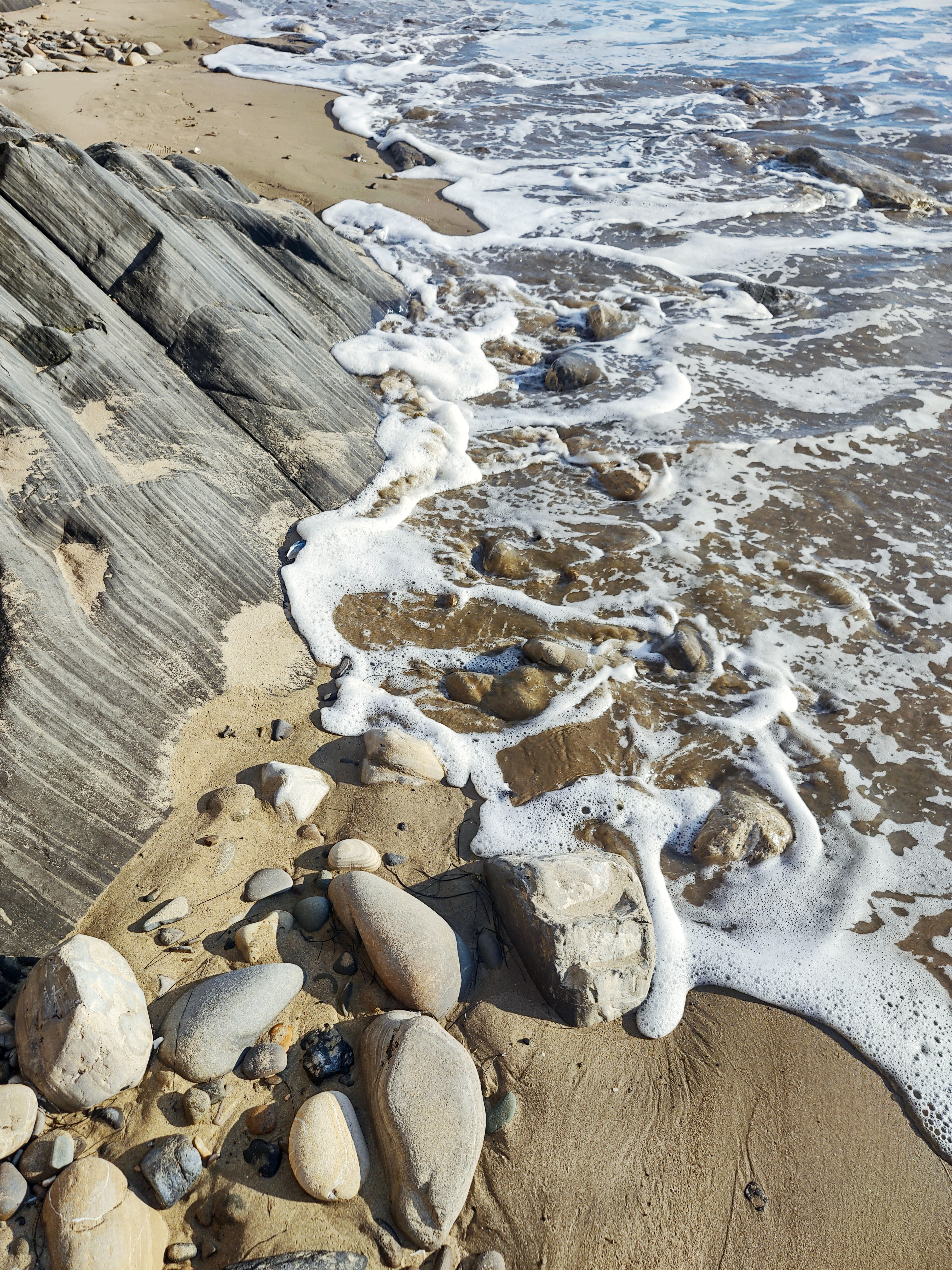 Shallow Water around Rock and Stones on Beach · Free Stock Photo
