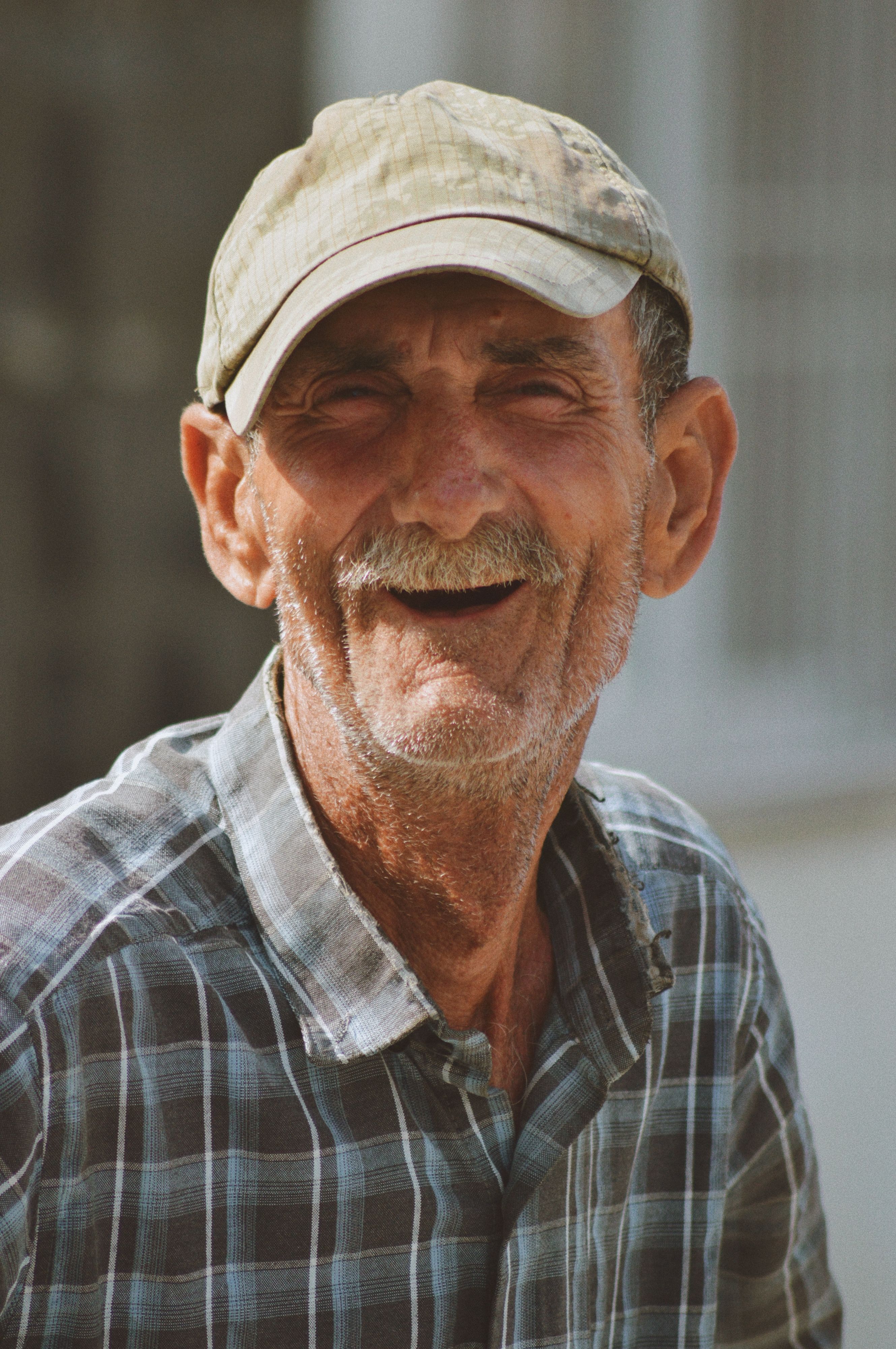 Portrait of a Smiling Elderly Man Sitting Outside in Sunlight · Free ...