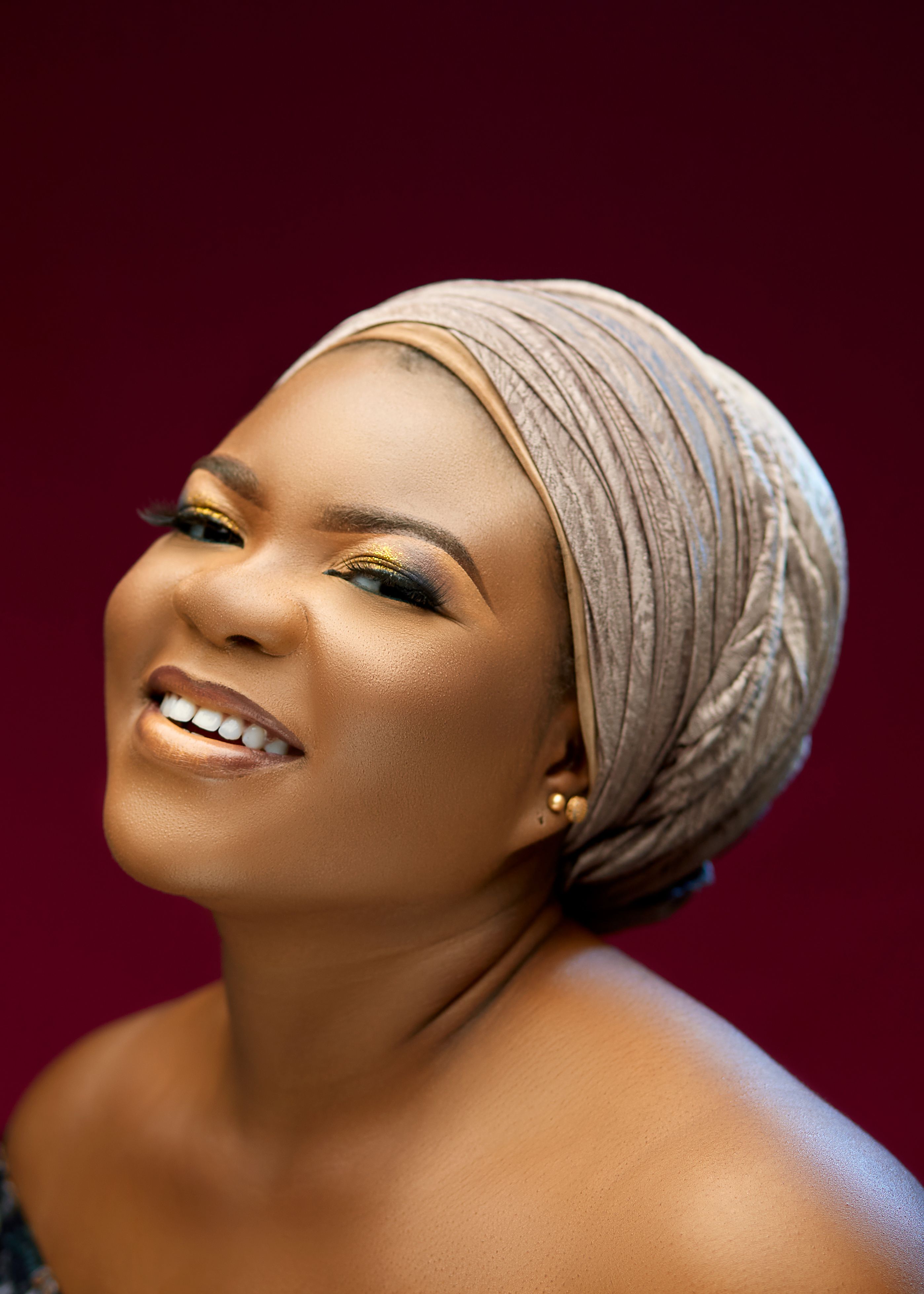 Smiling Woman in Turban Posing in Studio · Free Stock Photo