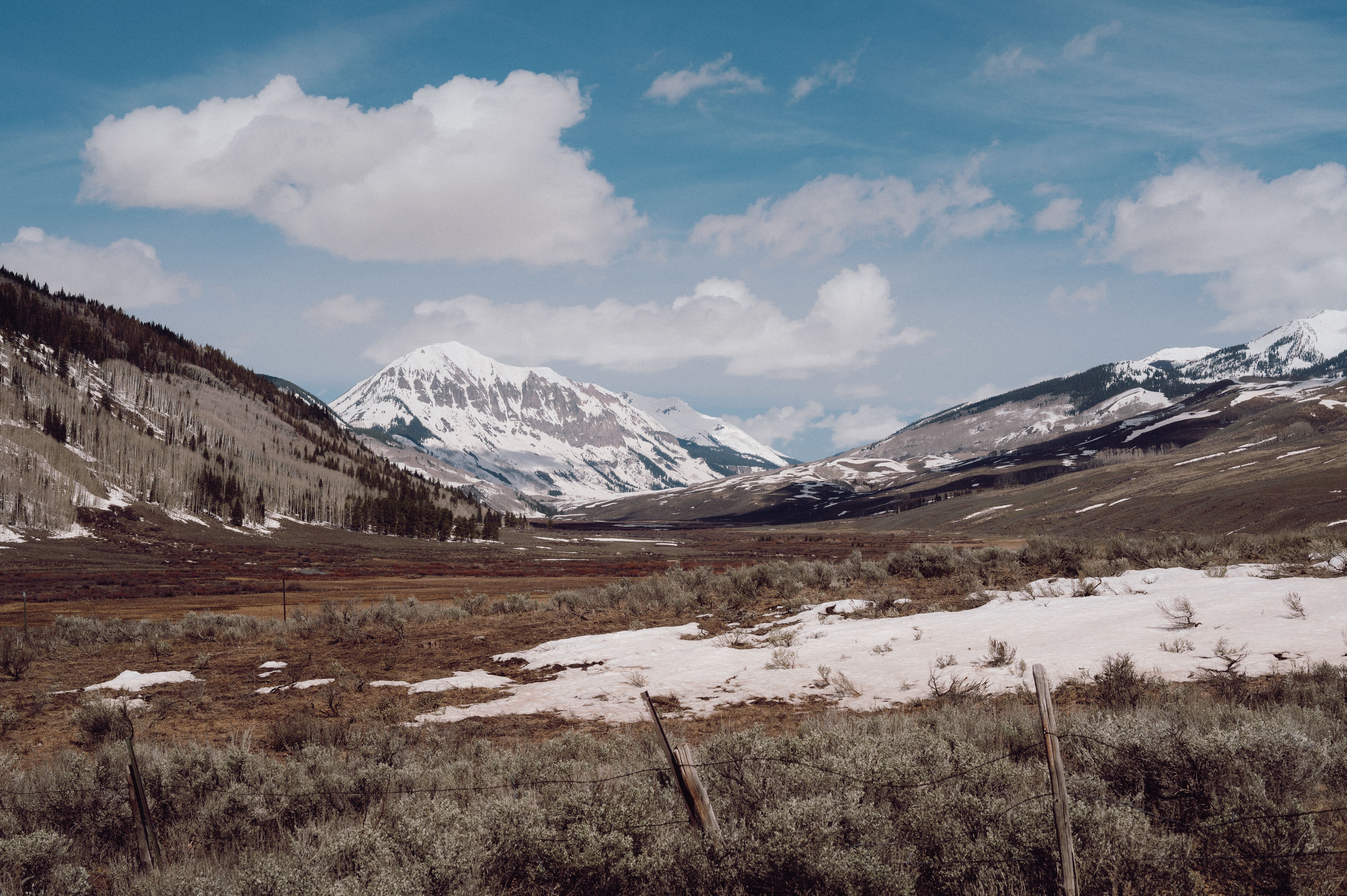 Snow in Valley with Hills and Mountain behind · Free Stock Photo