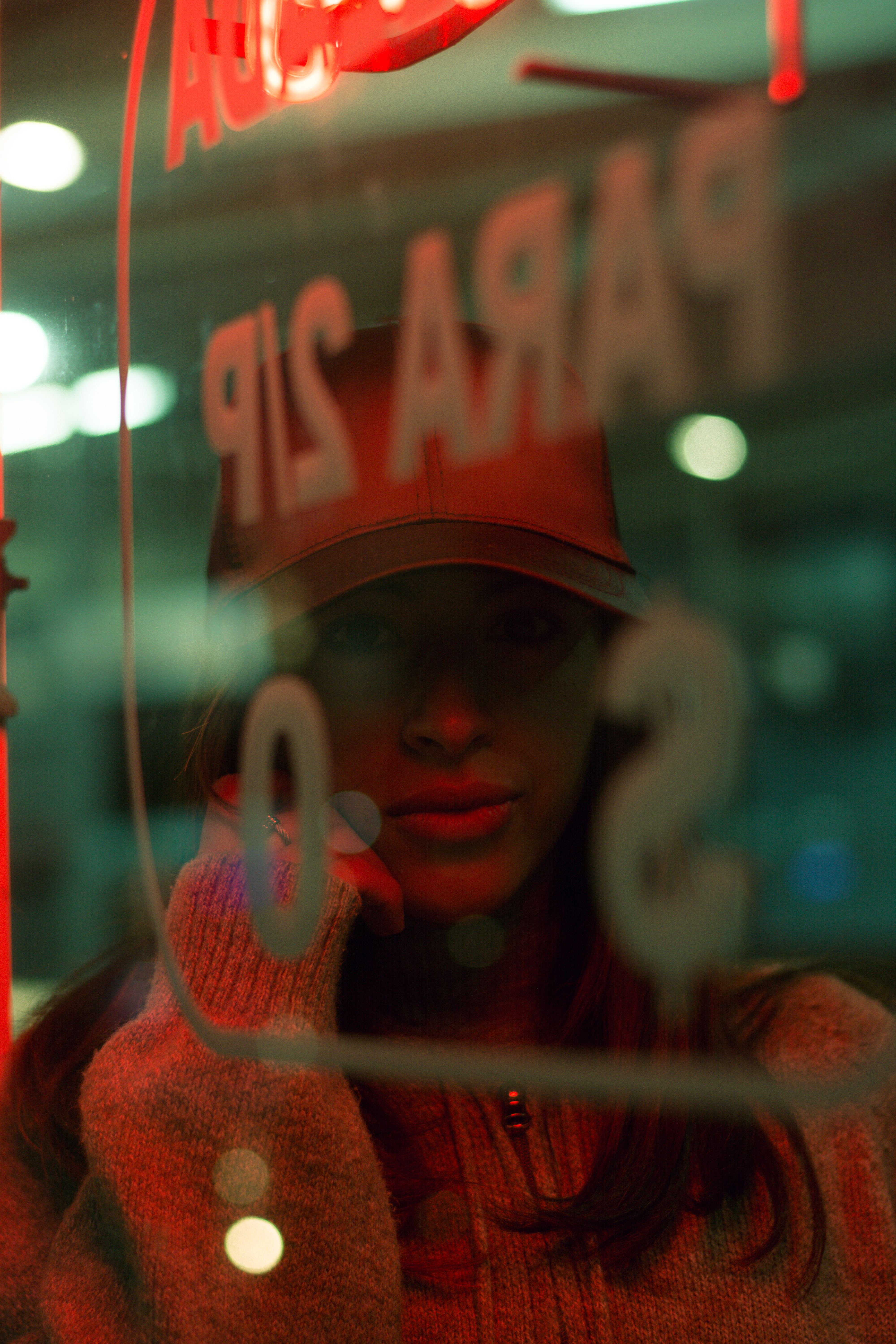 Woman in Cap behind Window · Free Stock Photo