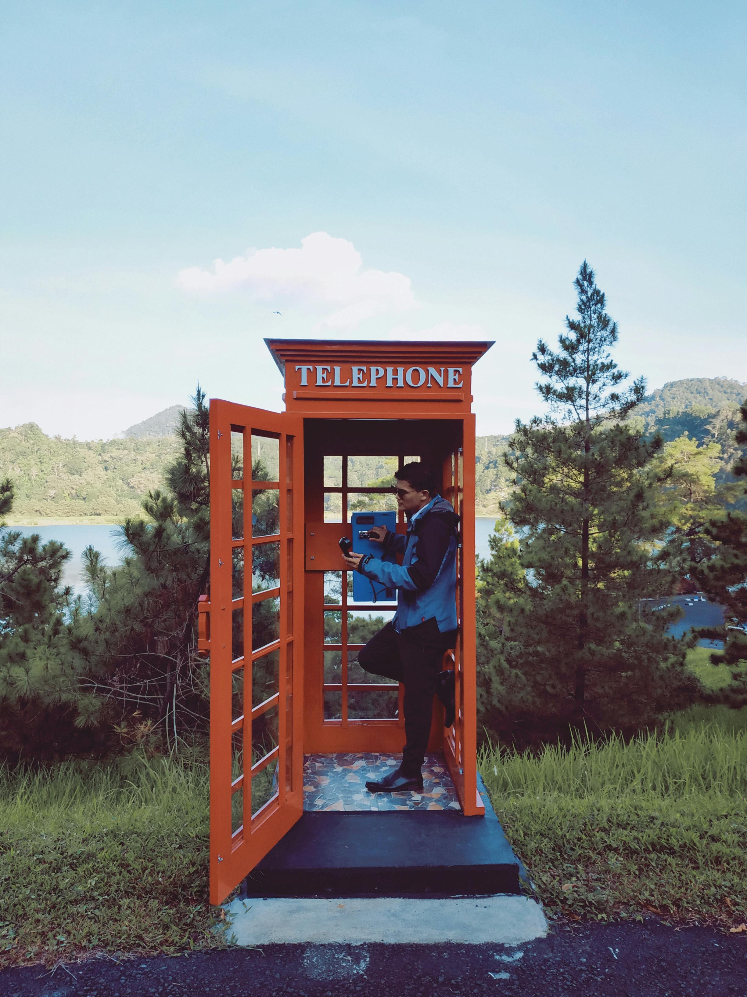 Man inside a Telephone Booth · Free Stock Photo