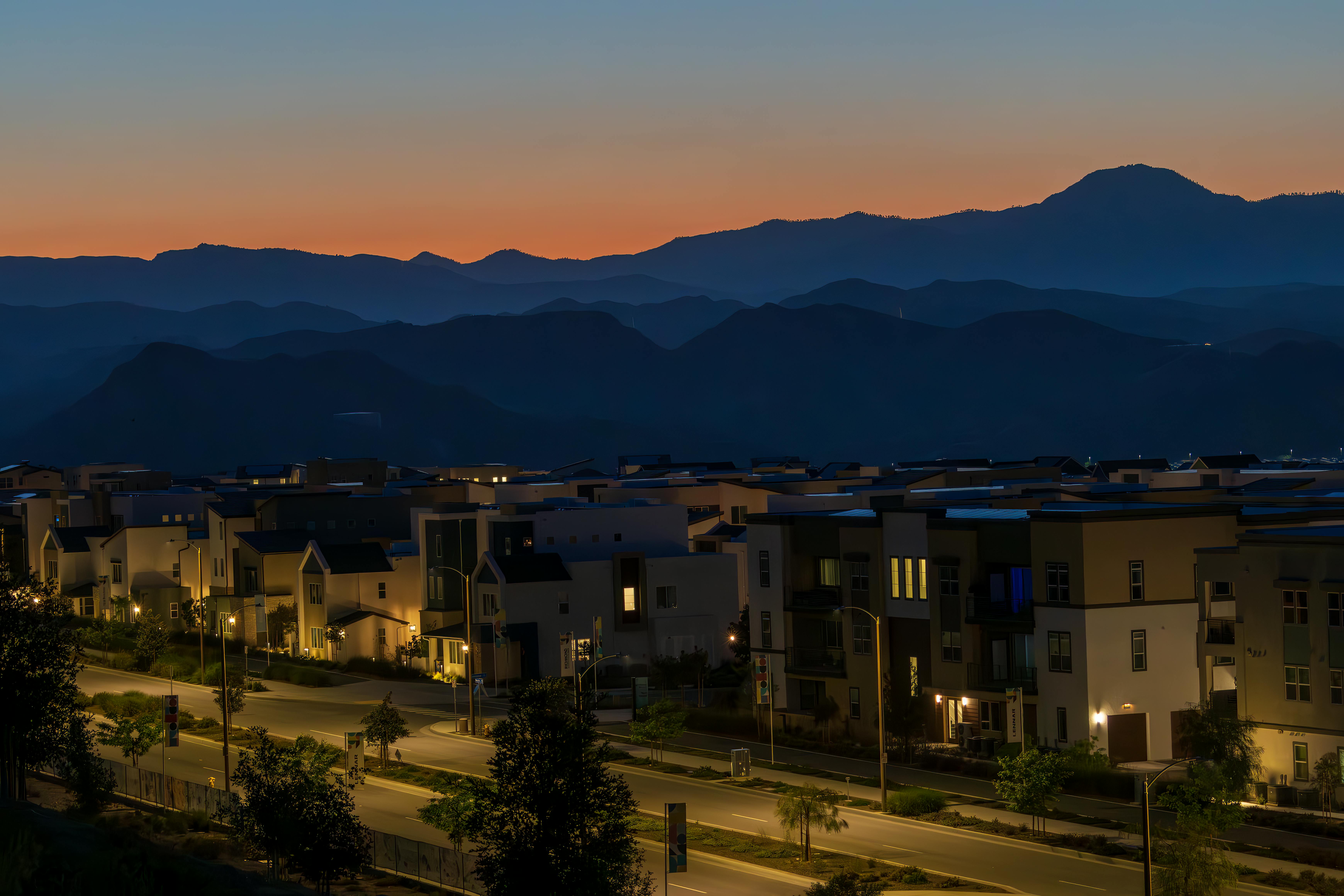 Evening Photo of a Residential Neighbourhood with Mountains in the ...
