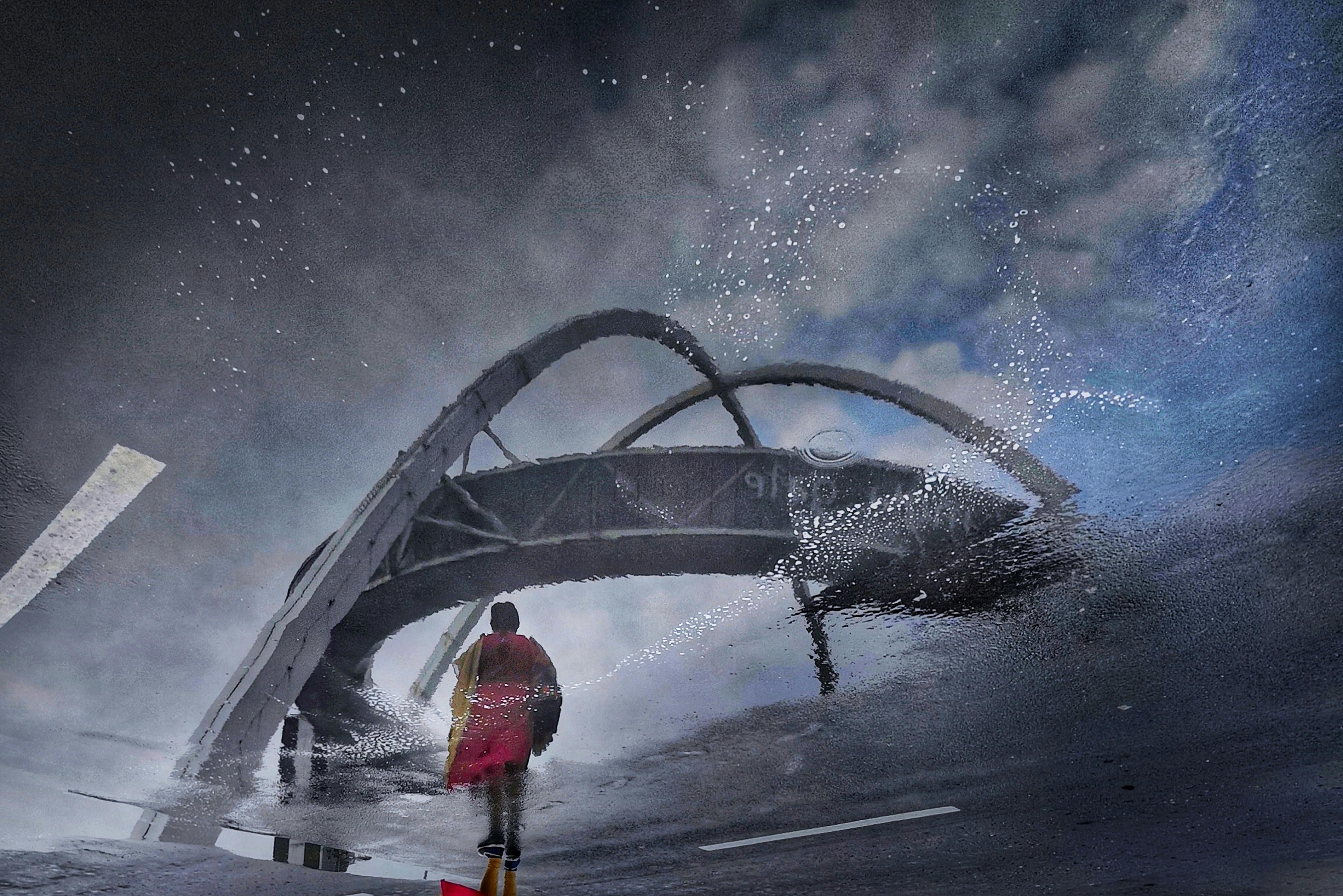 Person Walking on Road under Bridge · Free Stock Photo
