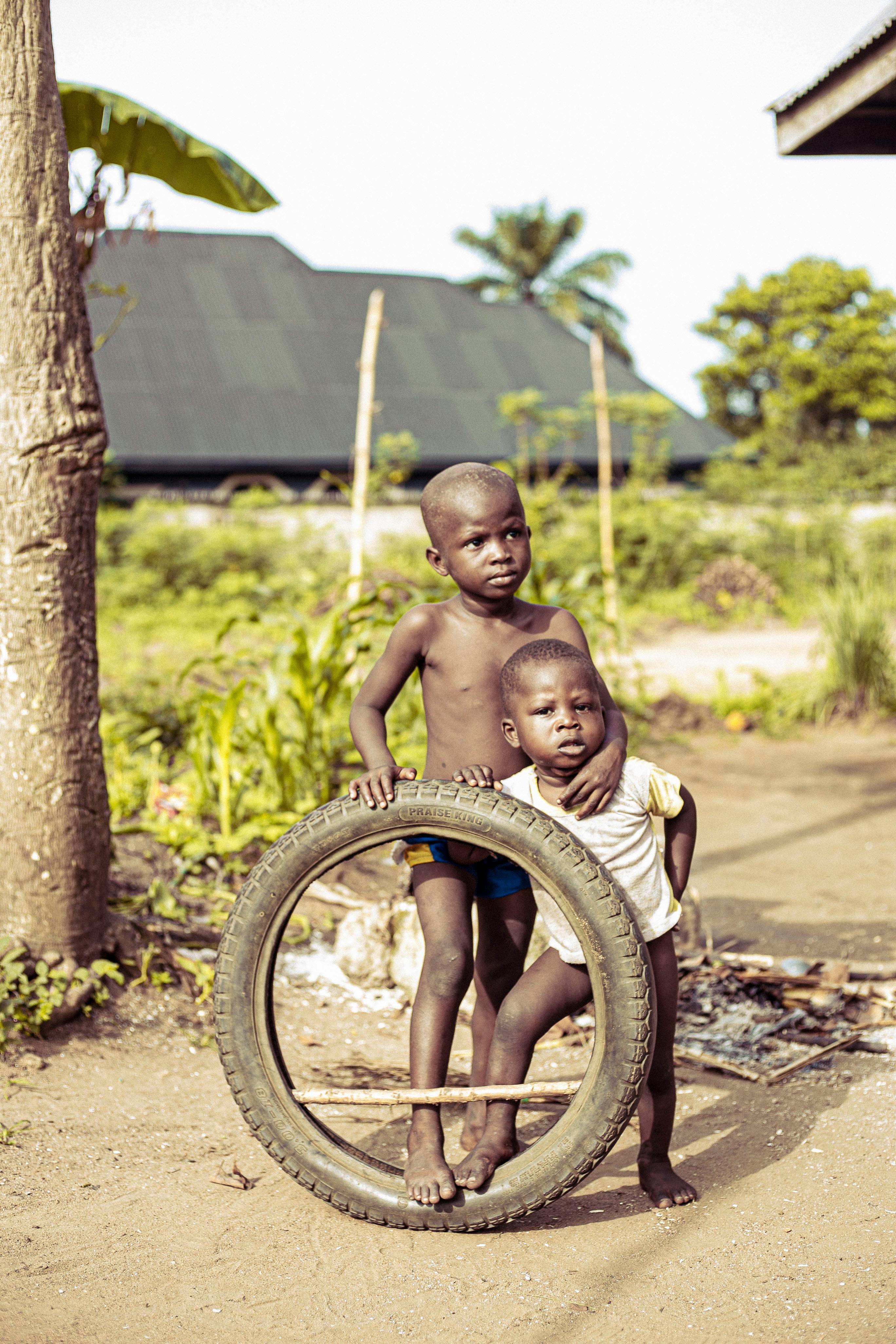 African Boys Holding a Tire · Free Stock Photo