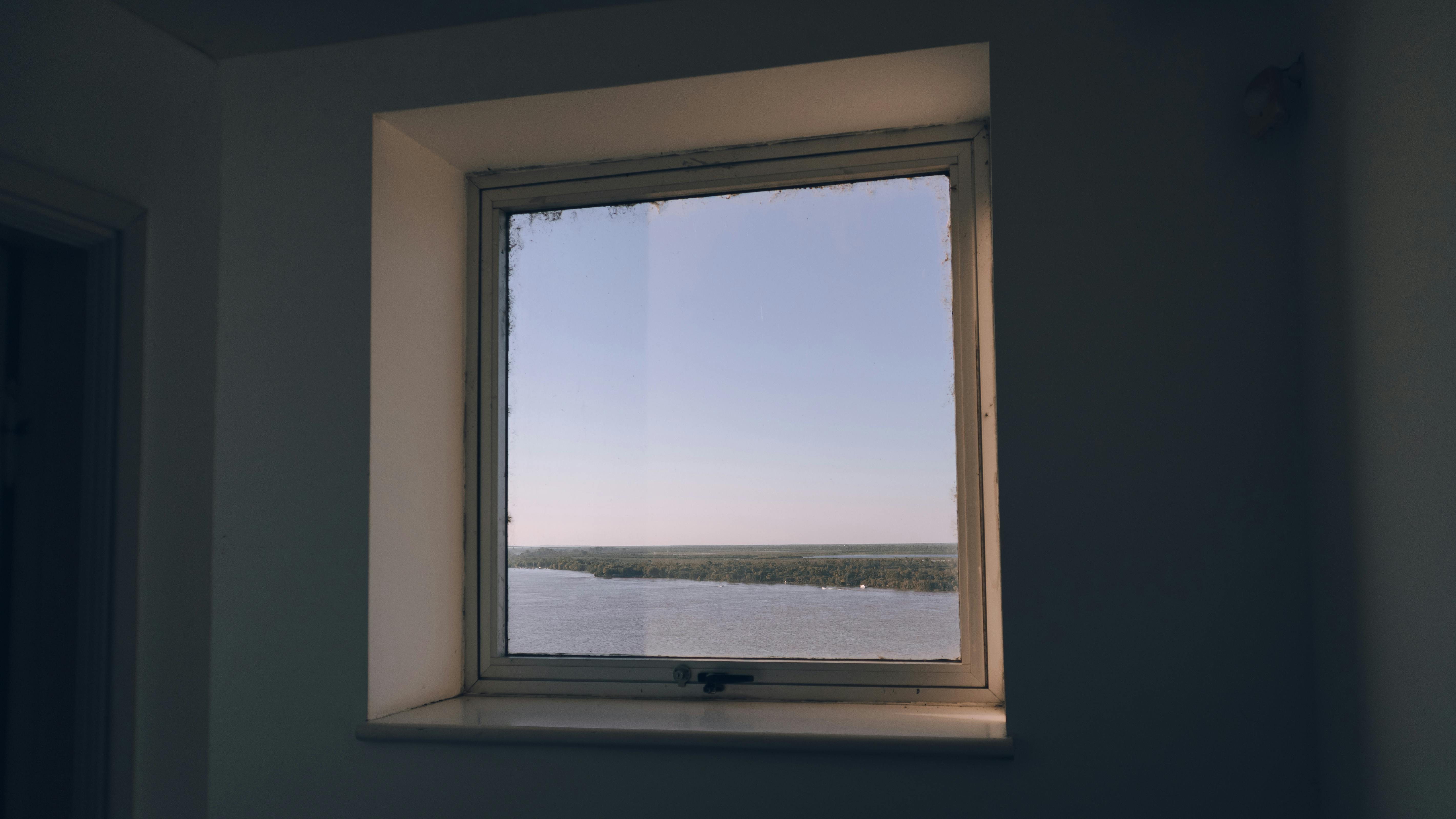 Empty Room with Large Window and Pictures on Wall · Free Stock Photo