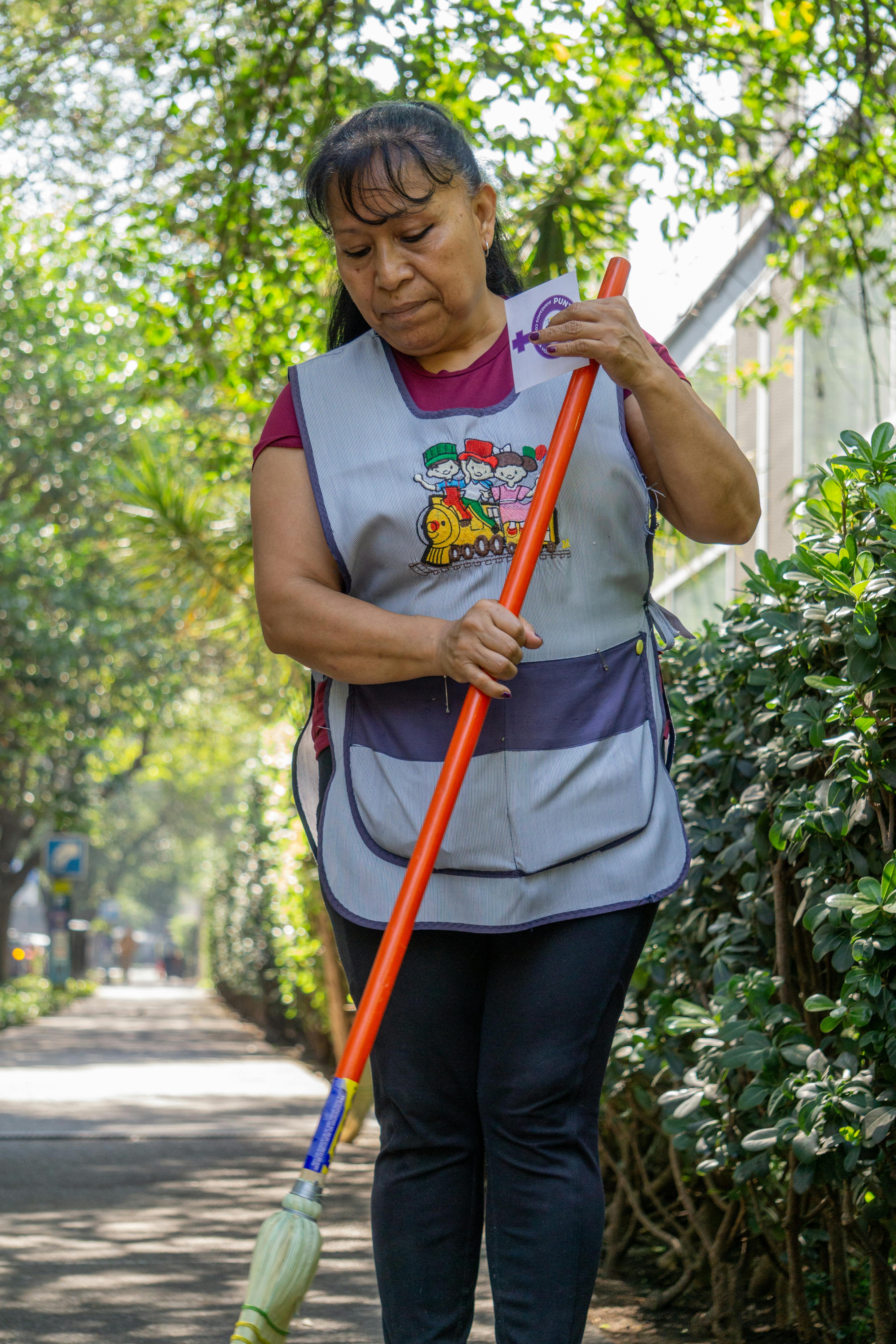 Woman Holding Broom on Street · Free Stock Photo