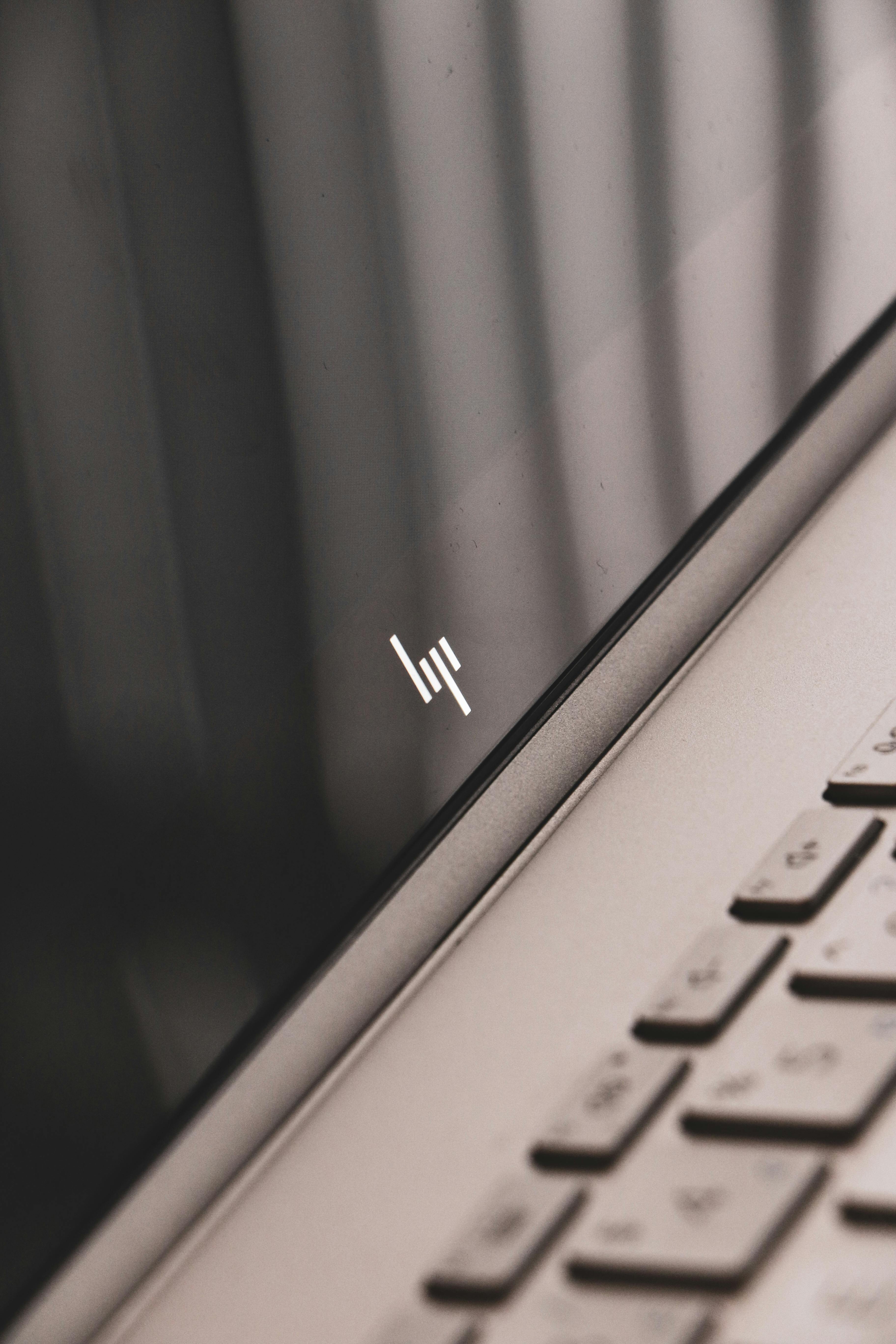 Close-Up Shot of a Laptop Computer on Gray Surface · Free Stock Photo