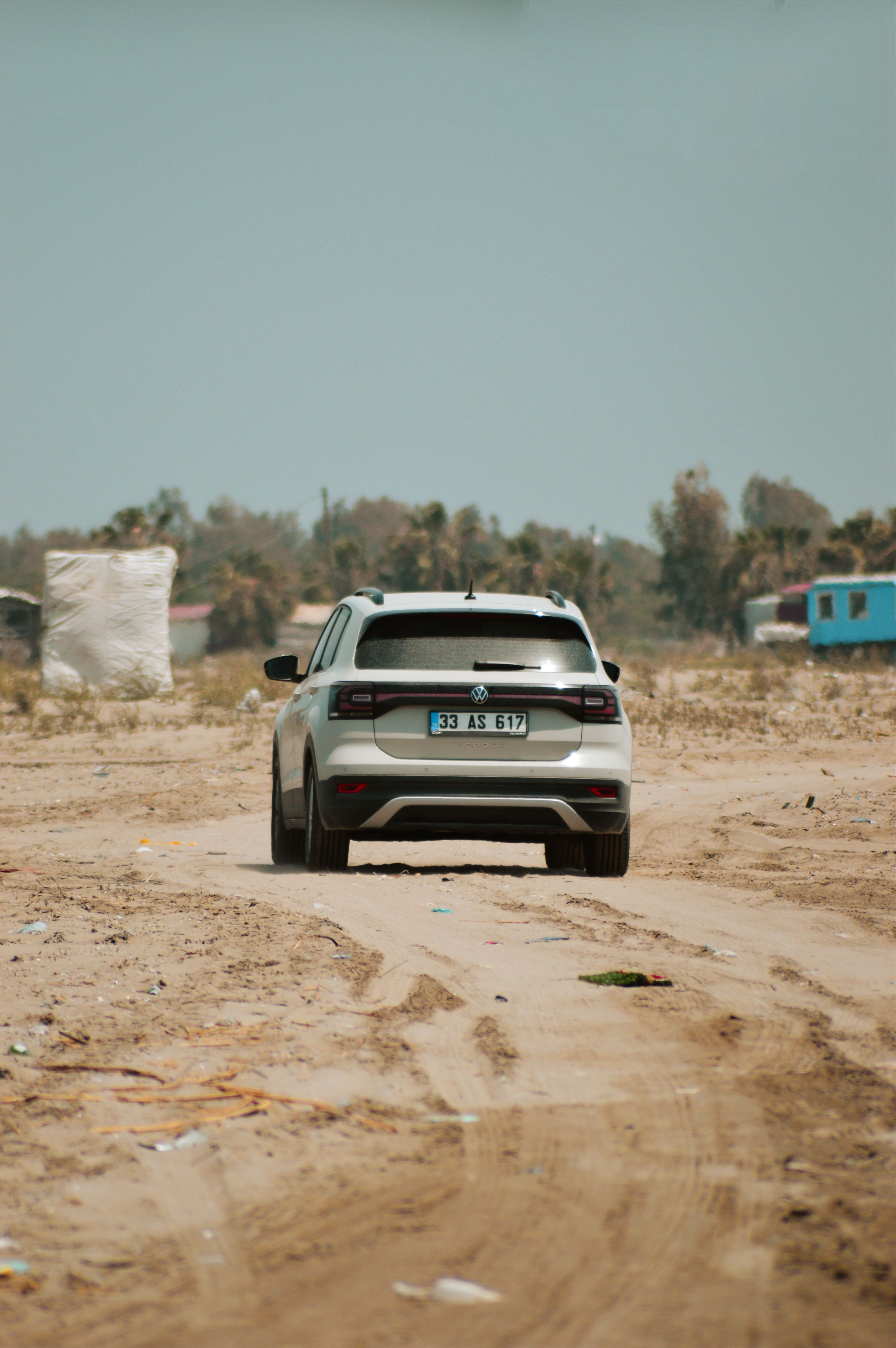 Back view of a Volkswagen T-Cross Driving on a Dirt Road · Free Stock Photo