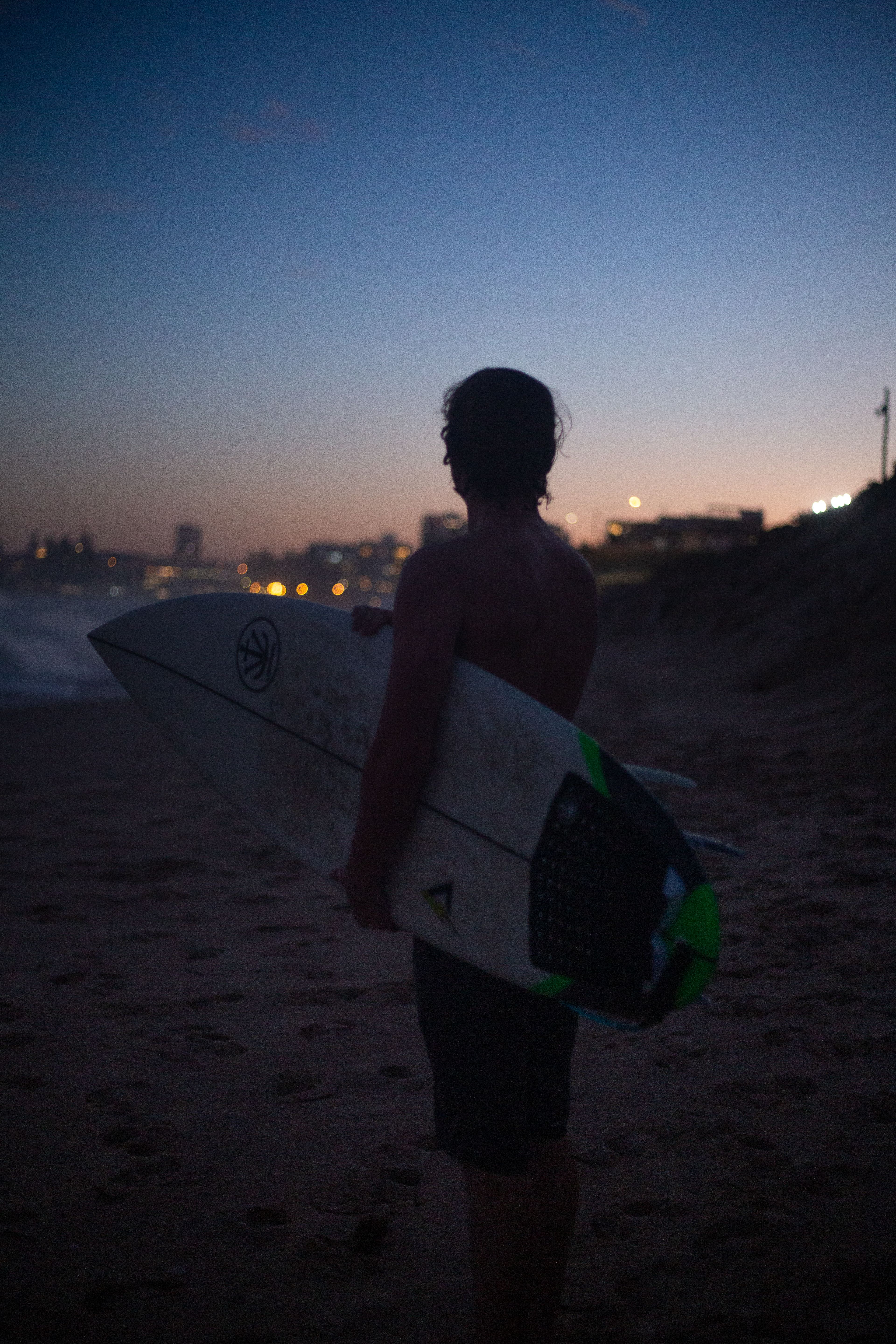Surfers on waves in ocean at sundown · Free Stock Photo