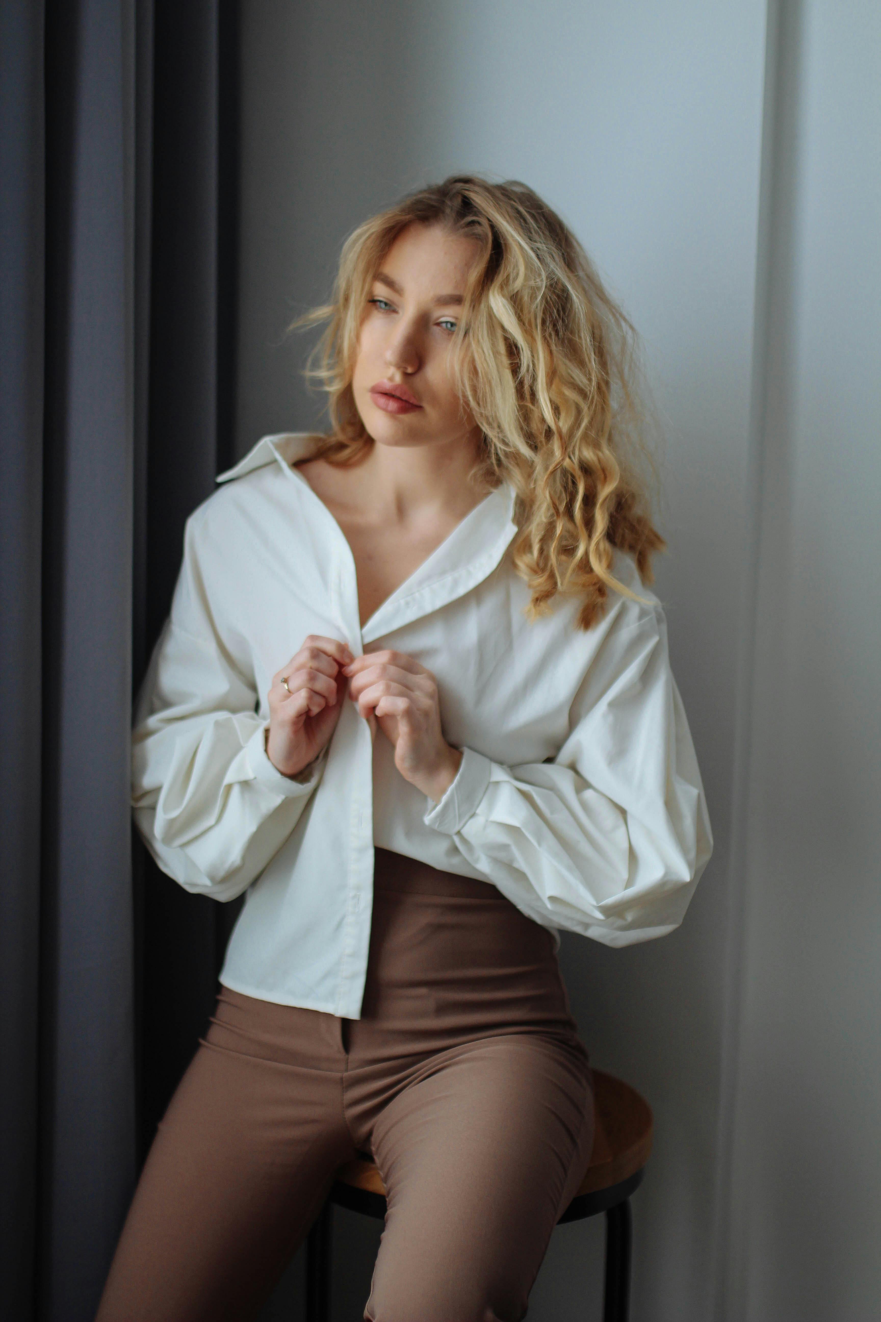 Young Model Unbuttoning Her Blouse · Free Stock Photo