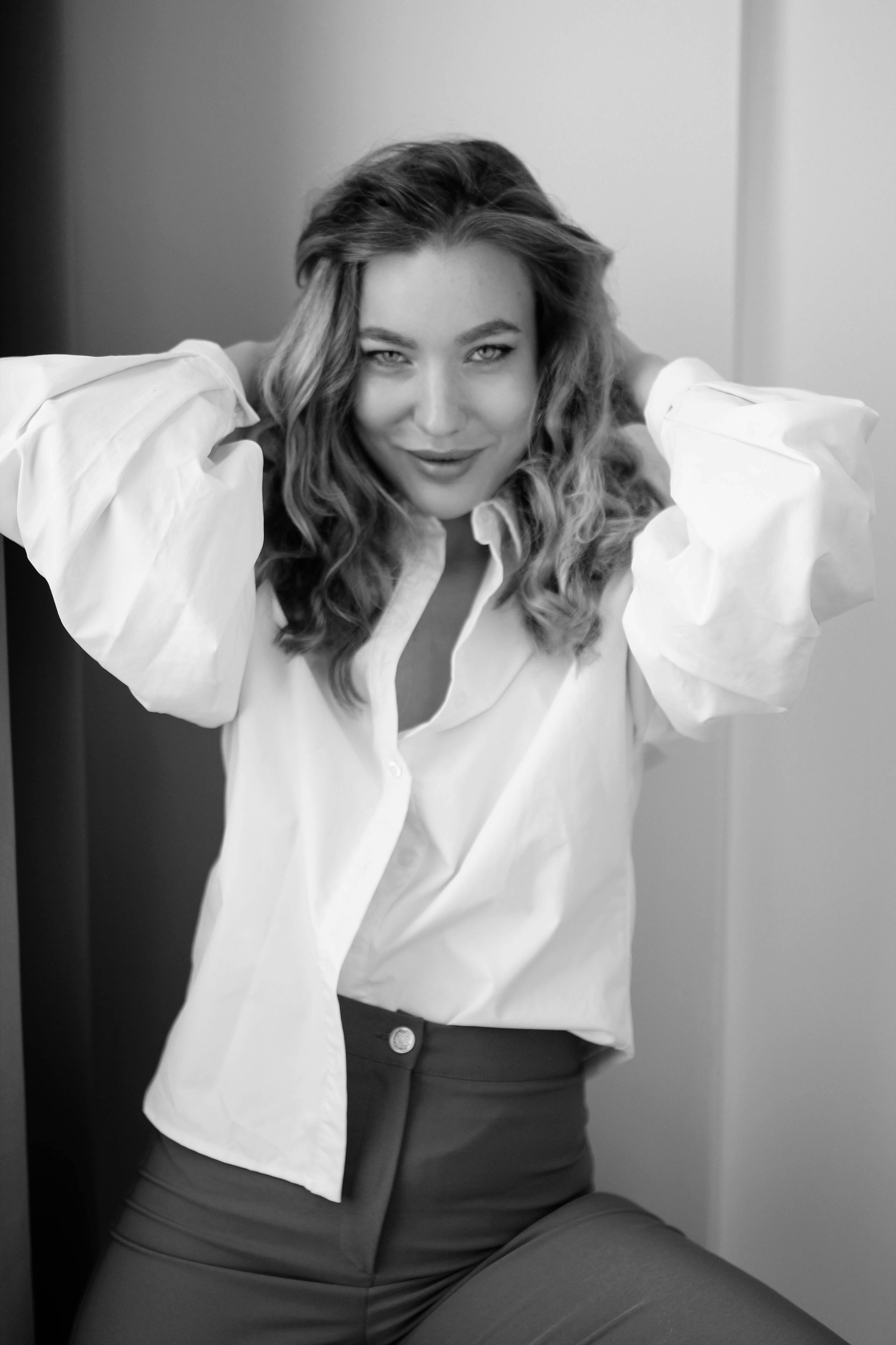 Smiling Woman Sitting on Floor and Leaning Arm on Stool · Free Stock Photo