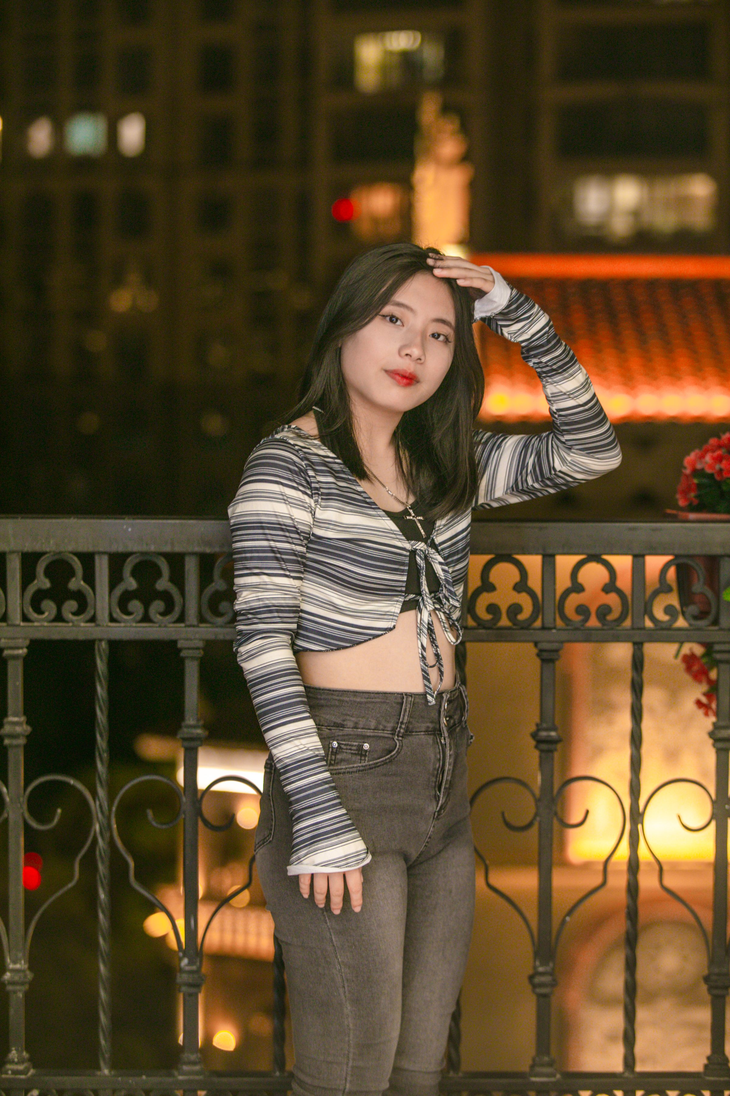 Female Model Wearing a Crop Top Posing on a Balcony at Night · Free ...